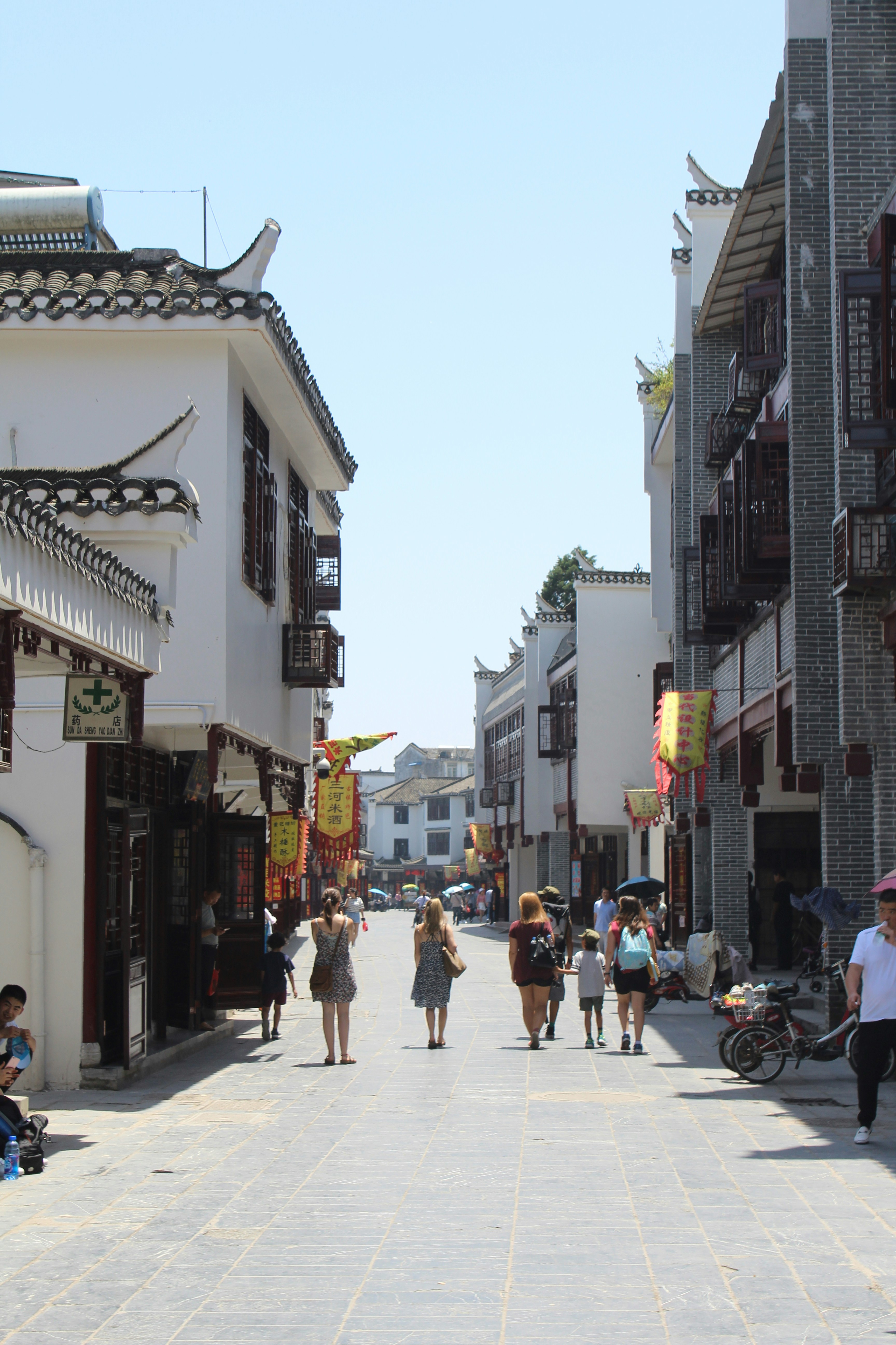 Sunlit Pedestrian Street Between Traditional Whitewashed Facades