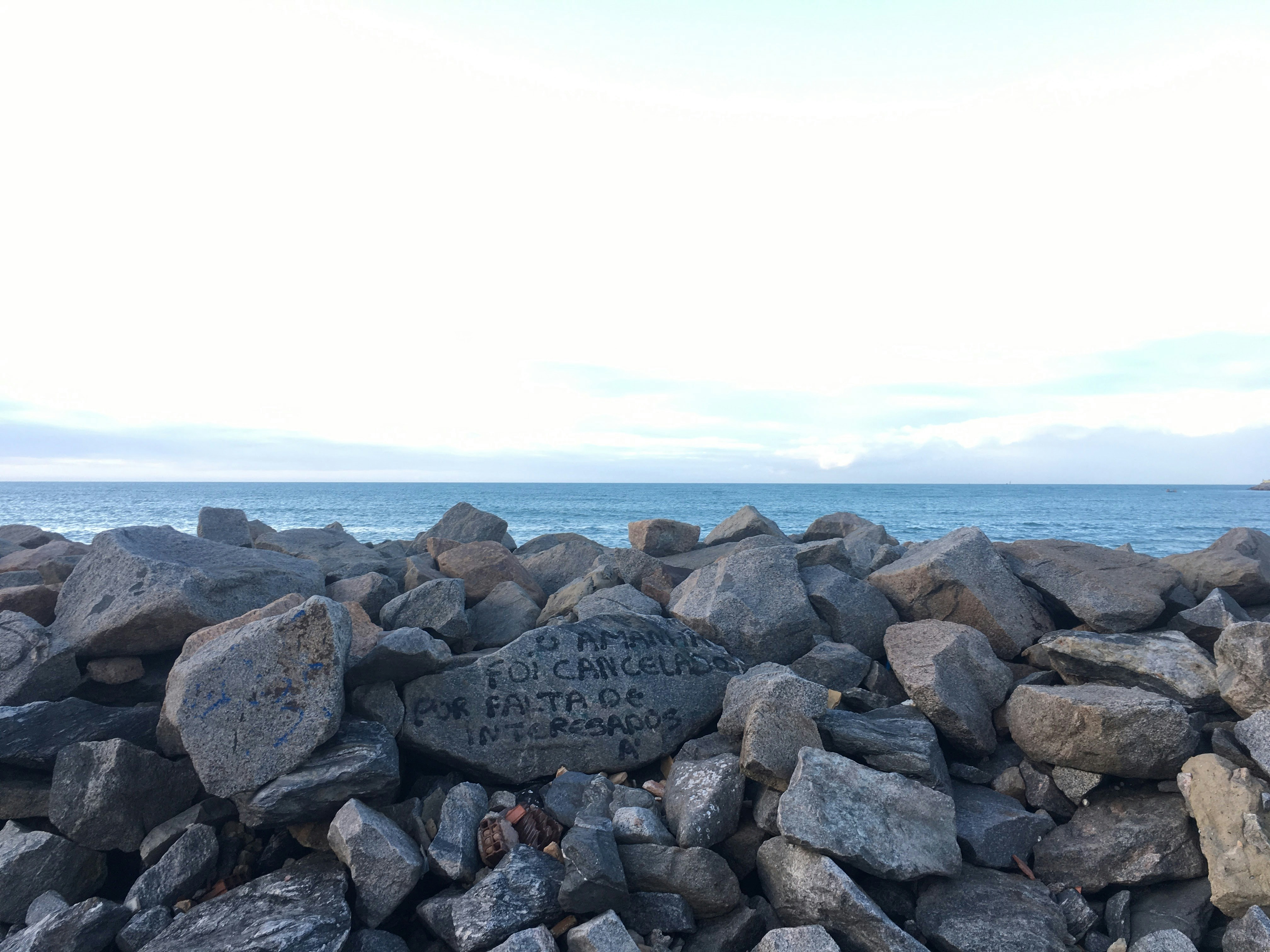 Rocky Breakwater Looking Toward Quiet Sea Horizon