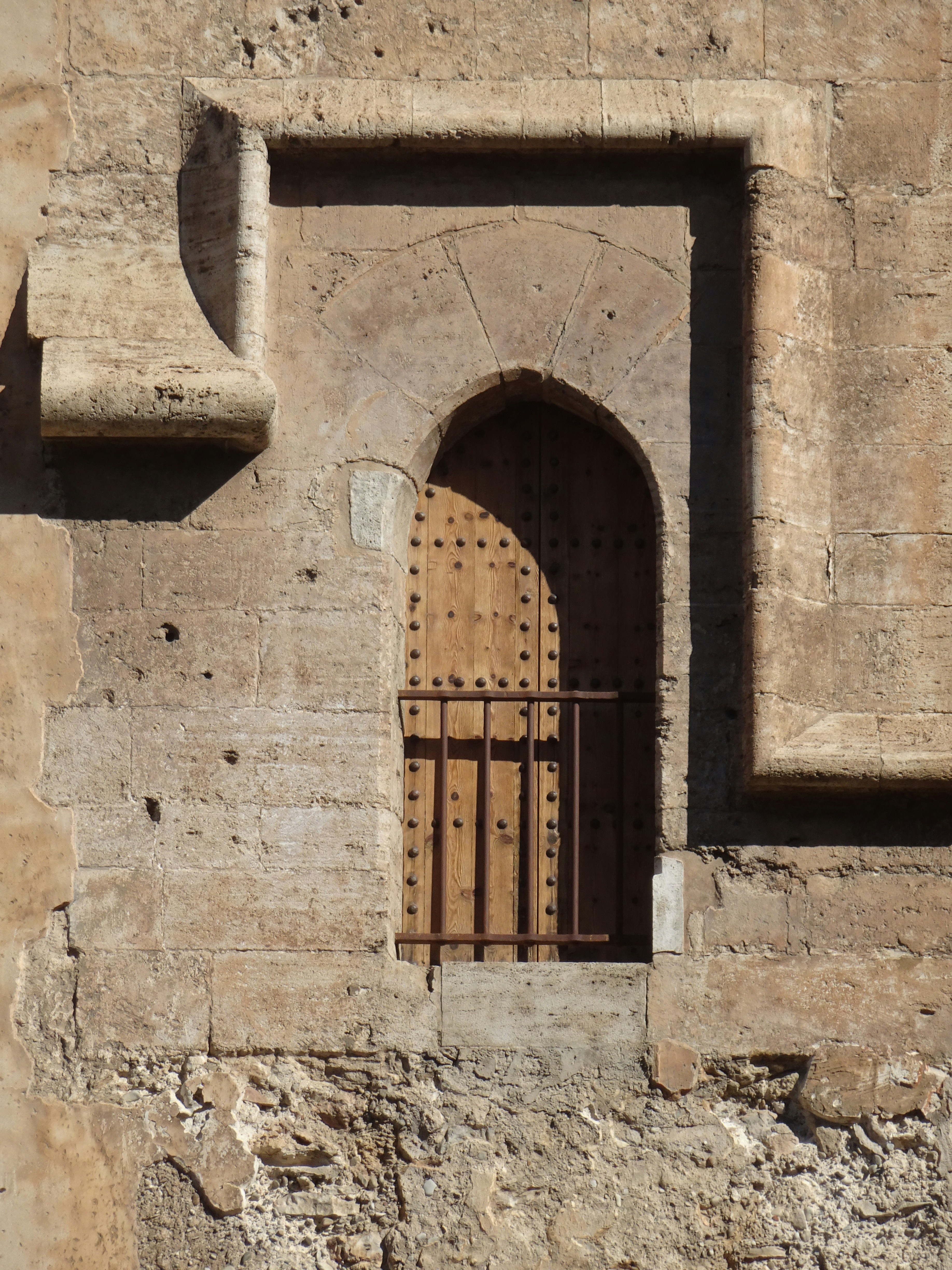 Stone Archway Gate Behind Weathered Fortified Walls