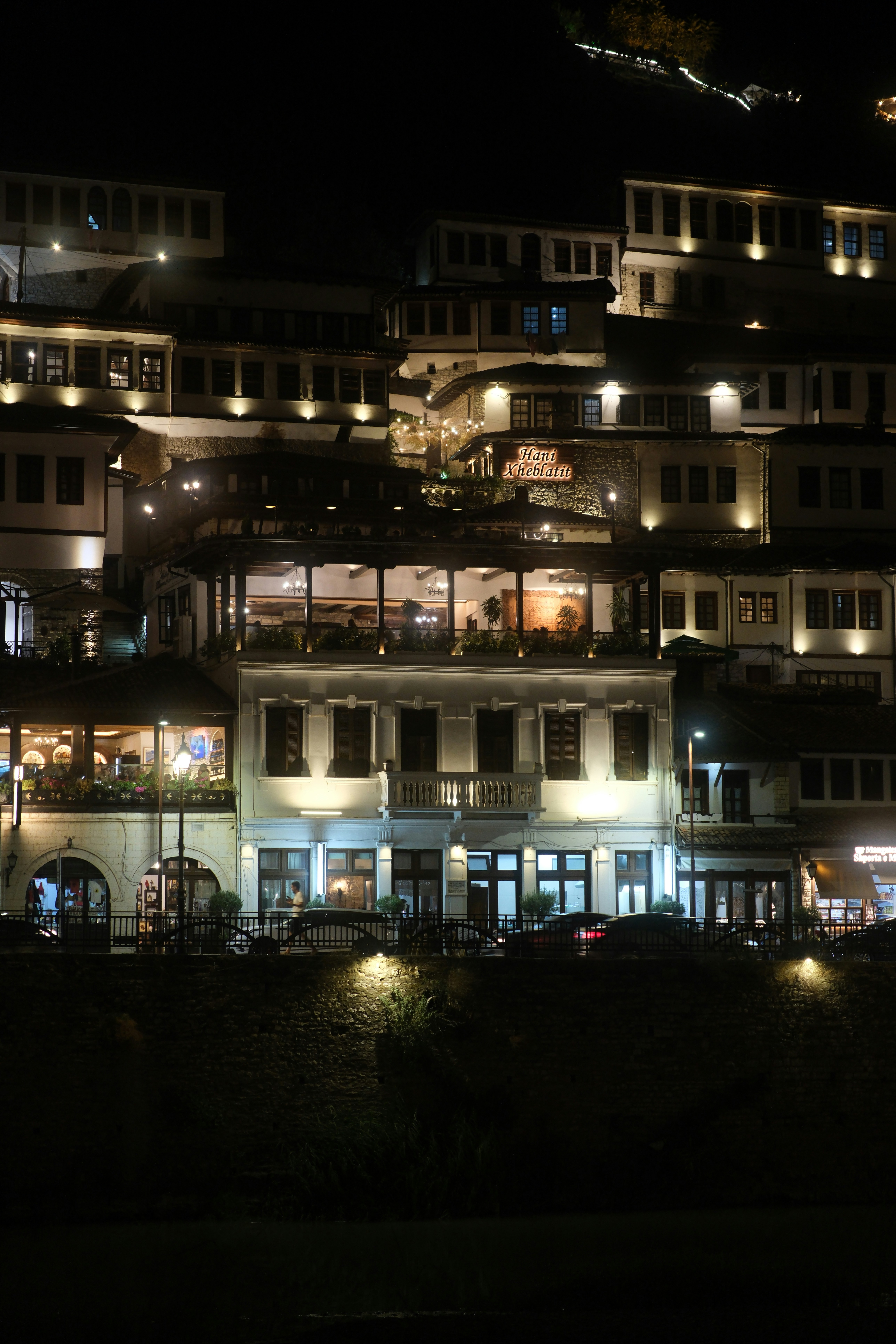 Luminous Facades: Nighttime stepped houses along the river