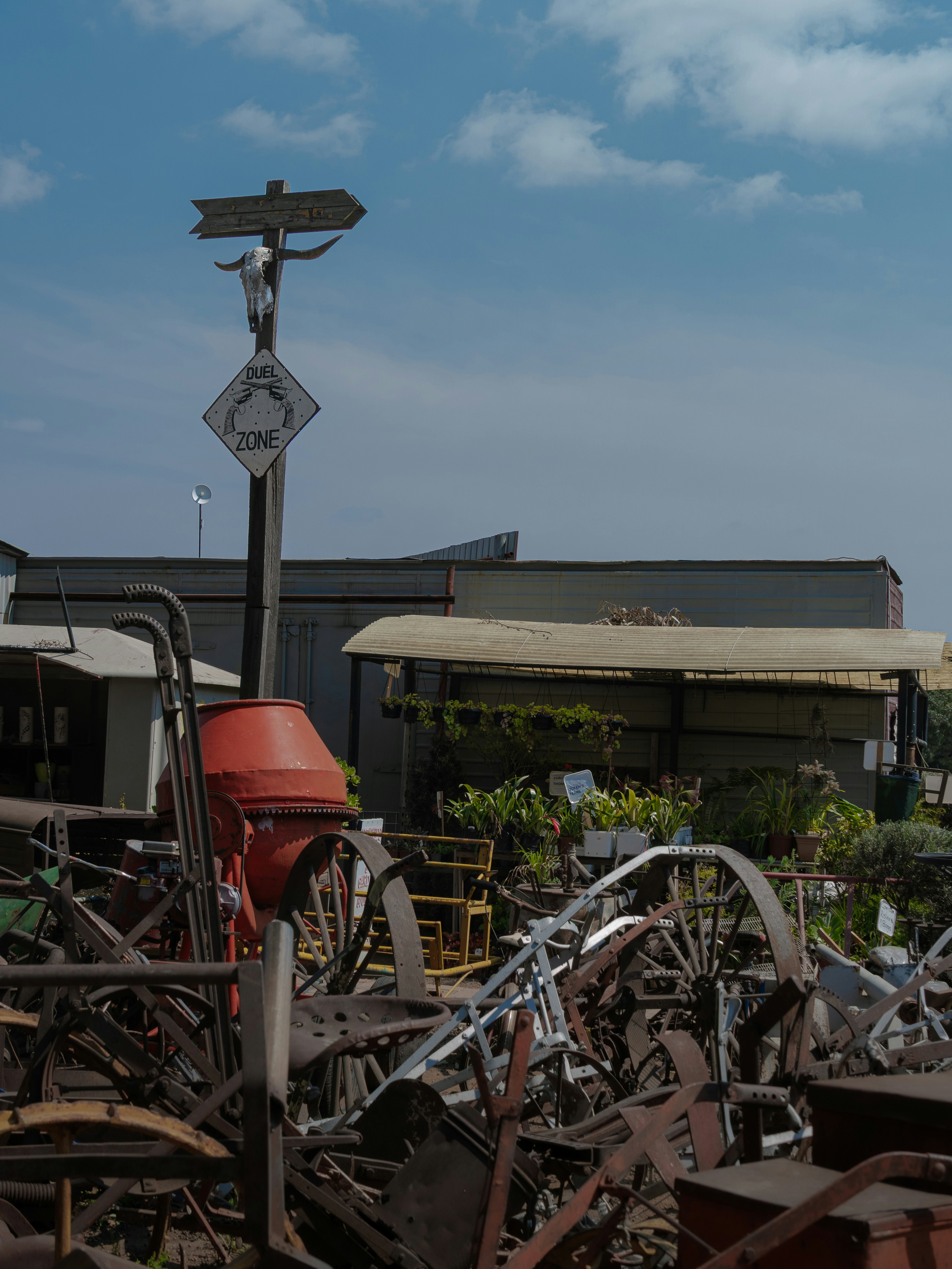 Defiant Crossroads: Salvage Yard Signposts under a Clear Sky
