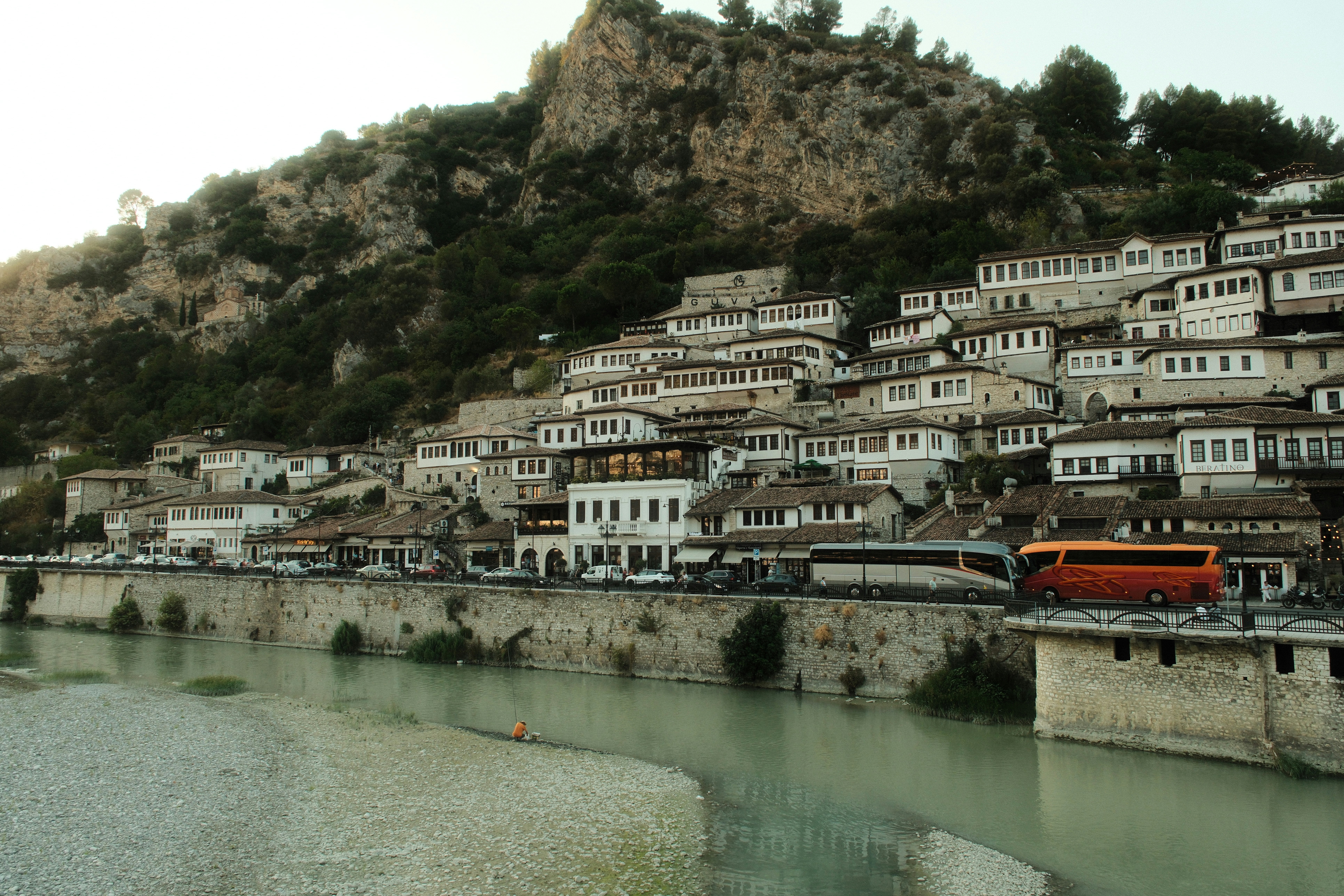 Terraced village on a hillside by a calm river