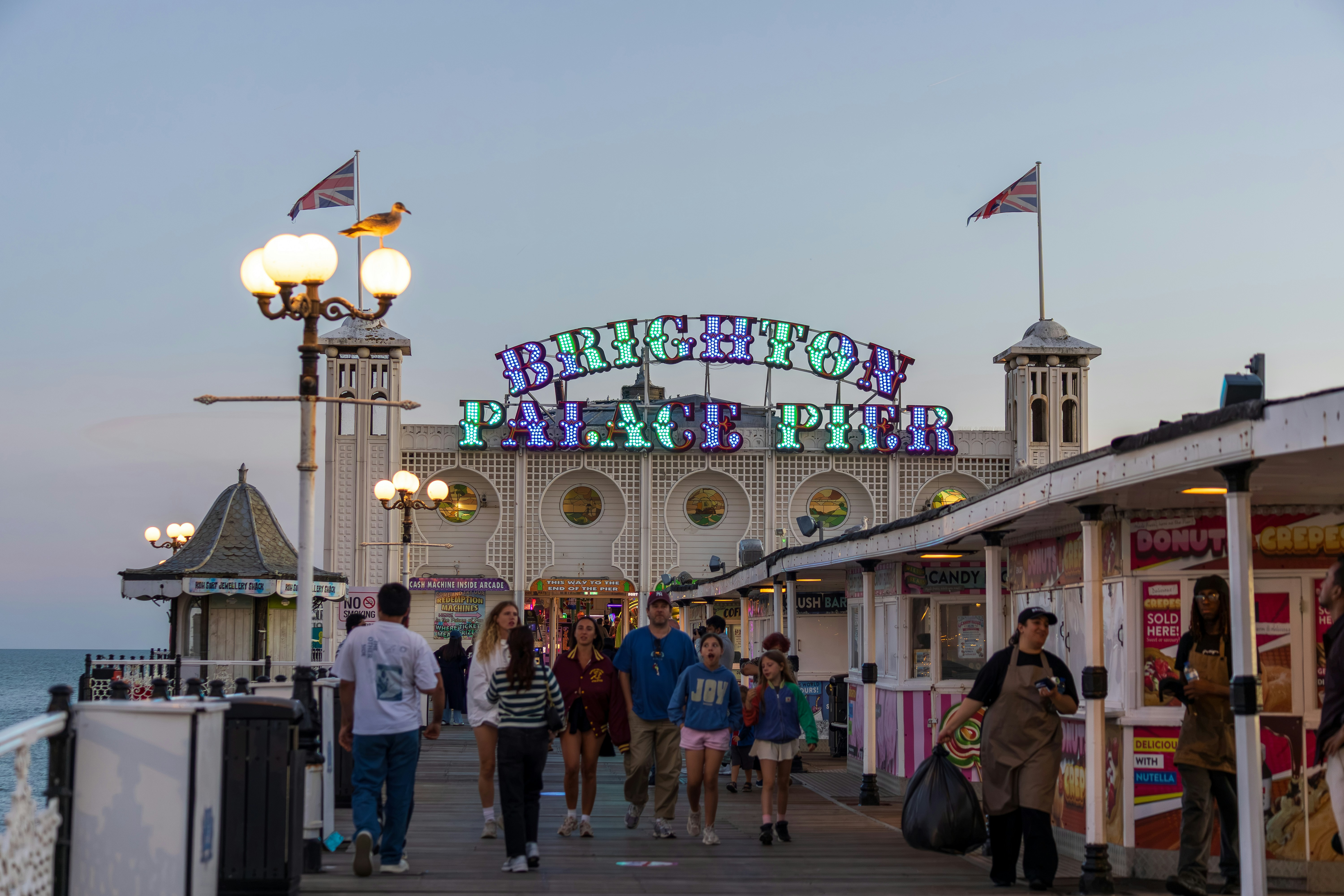 Brighton Pier Entrance: Neon Sign and Piergoers
