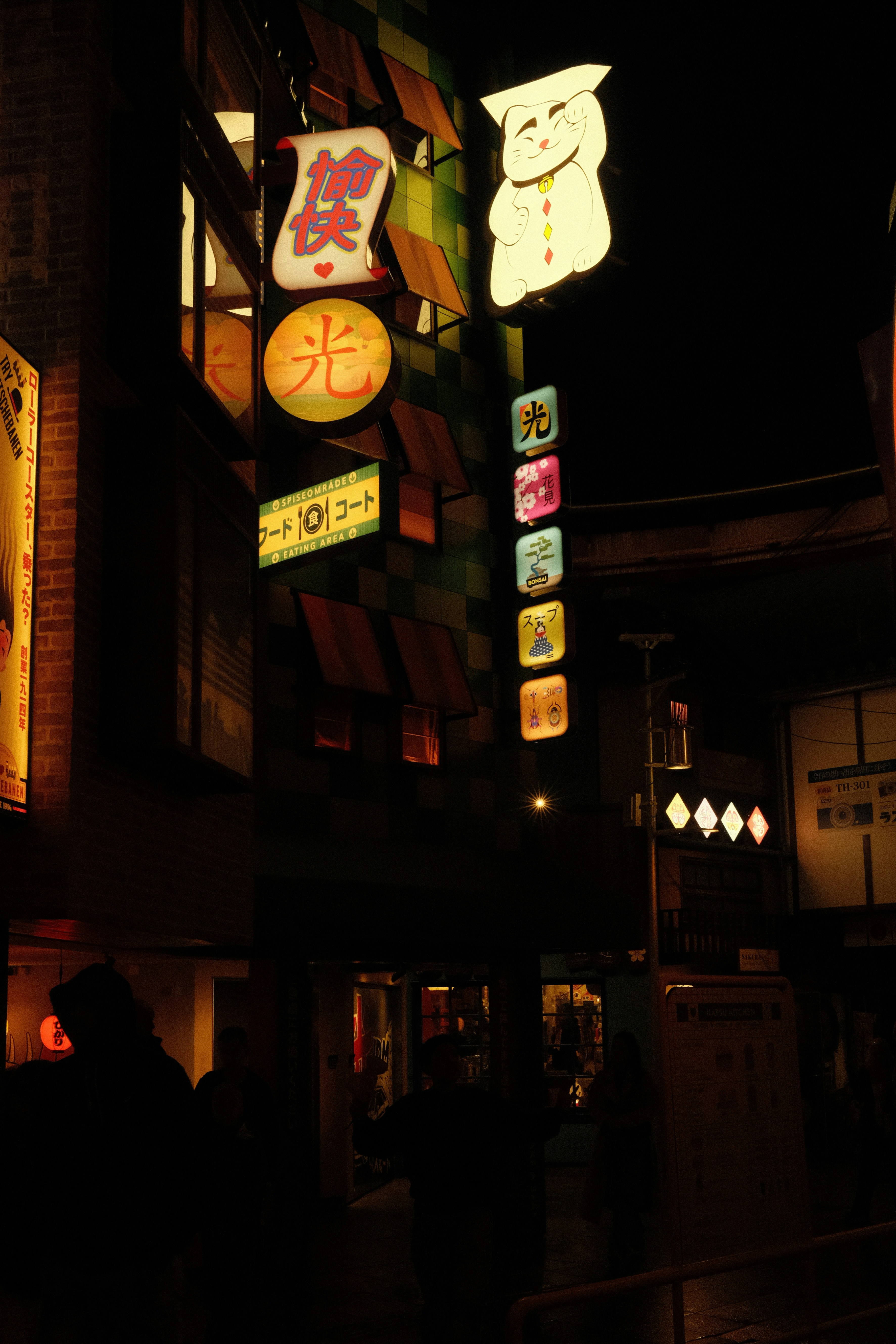 Neon Cat Signage Over a Night Street Corridor