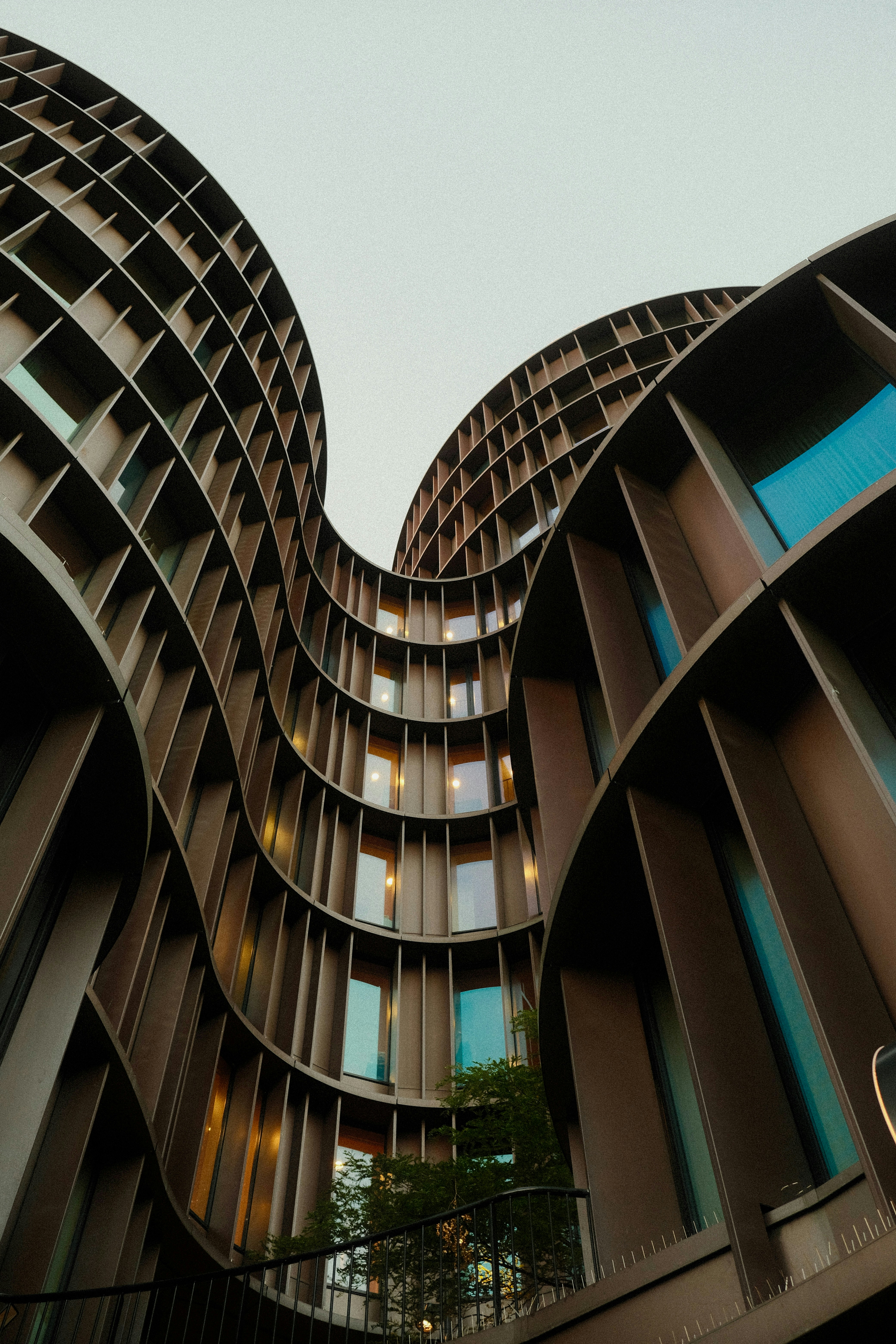 Curves of Steel: A Courtyard Shadowed by Sculpted Facades