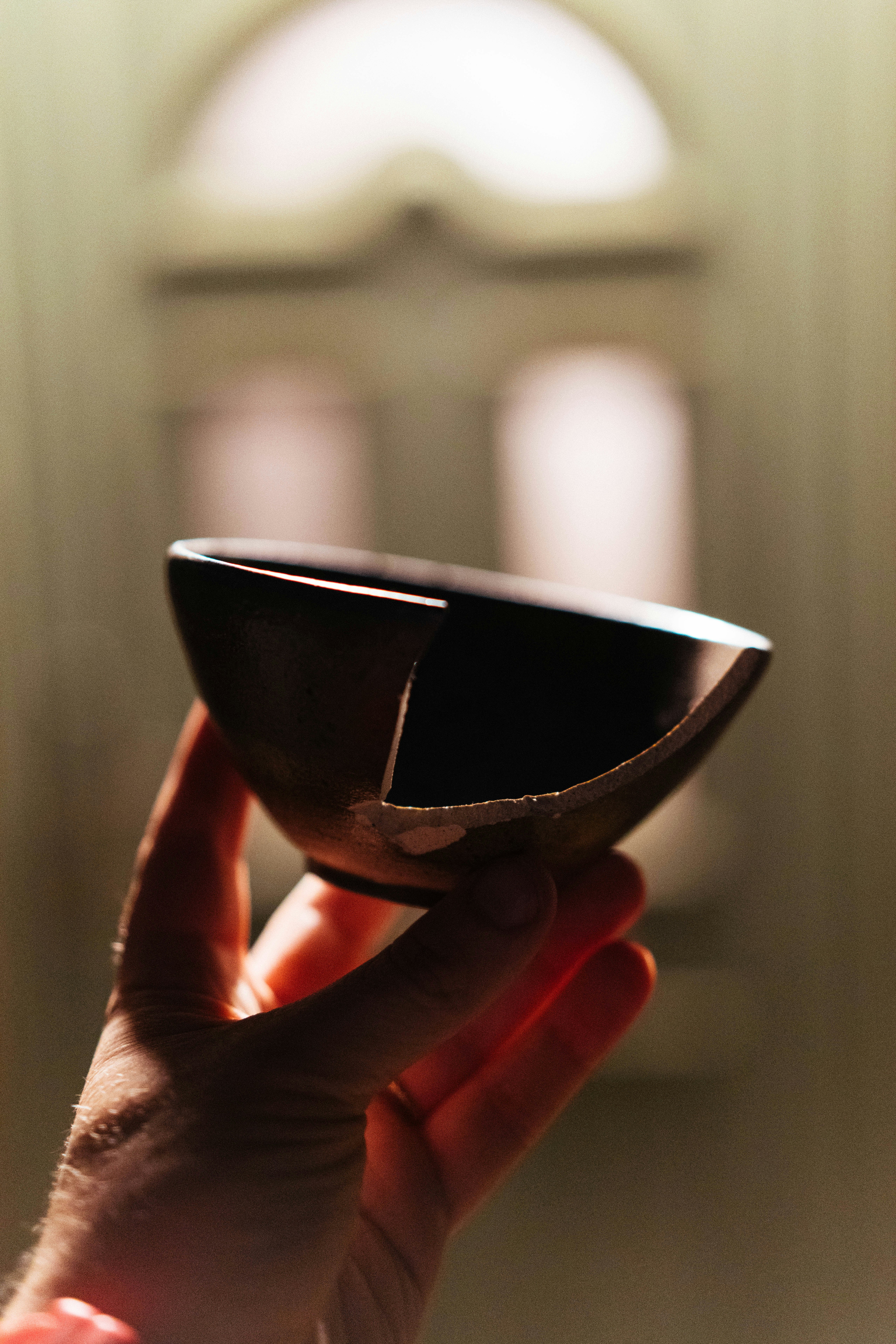 Half-Forgotten Vessel: Fractured Cup in Warm Streetlight