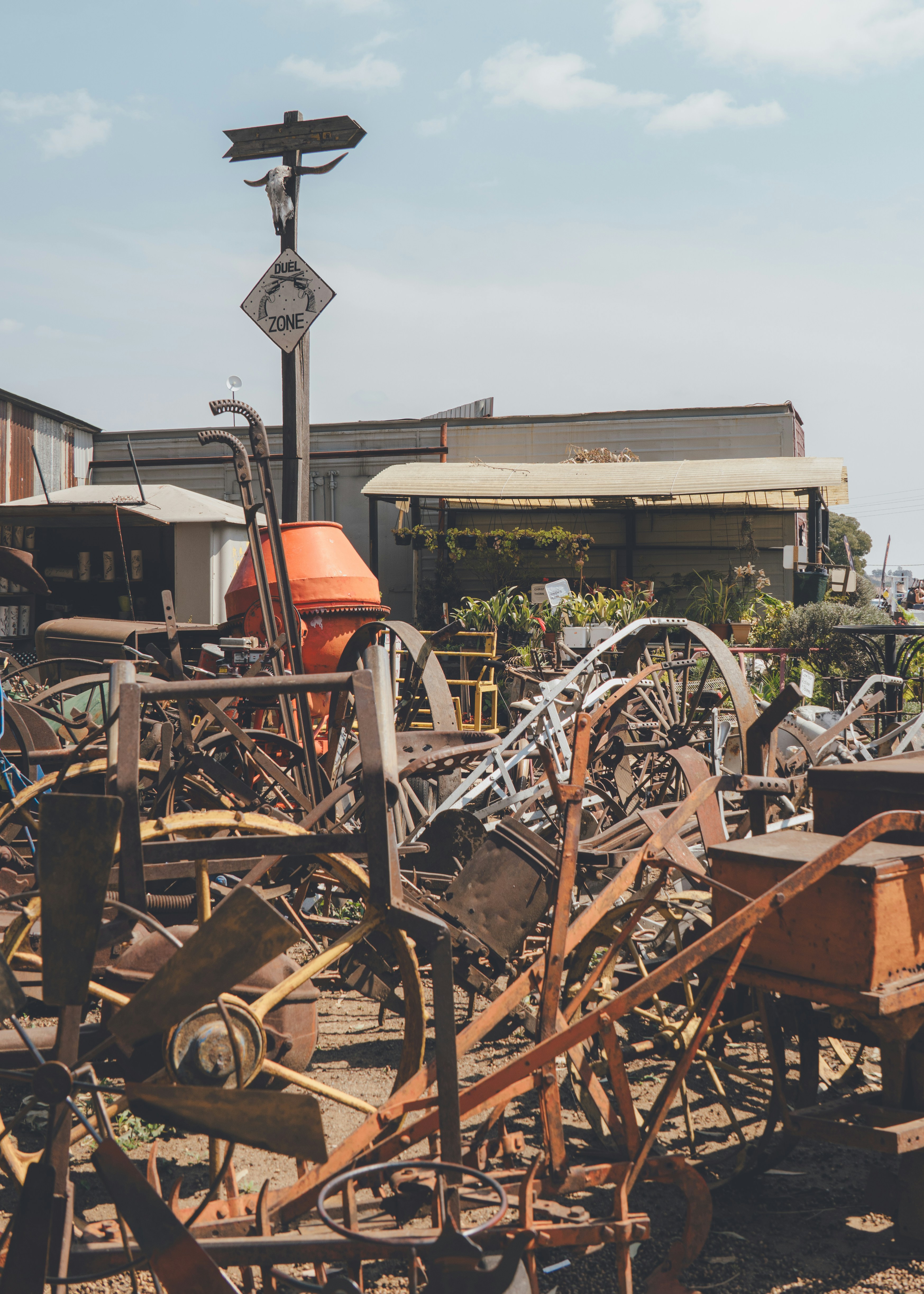 Deserted scrapyard crossroads under a quiet sky