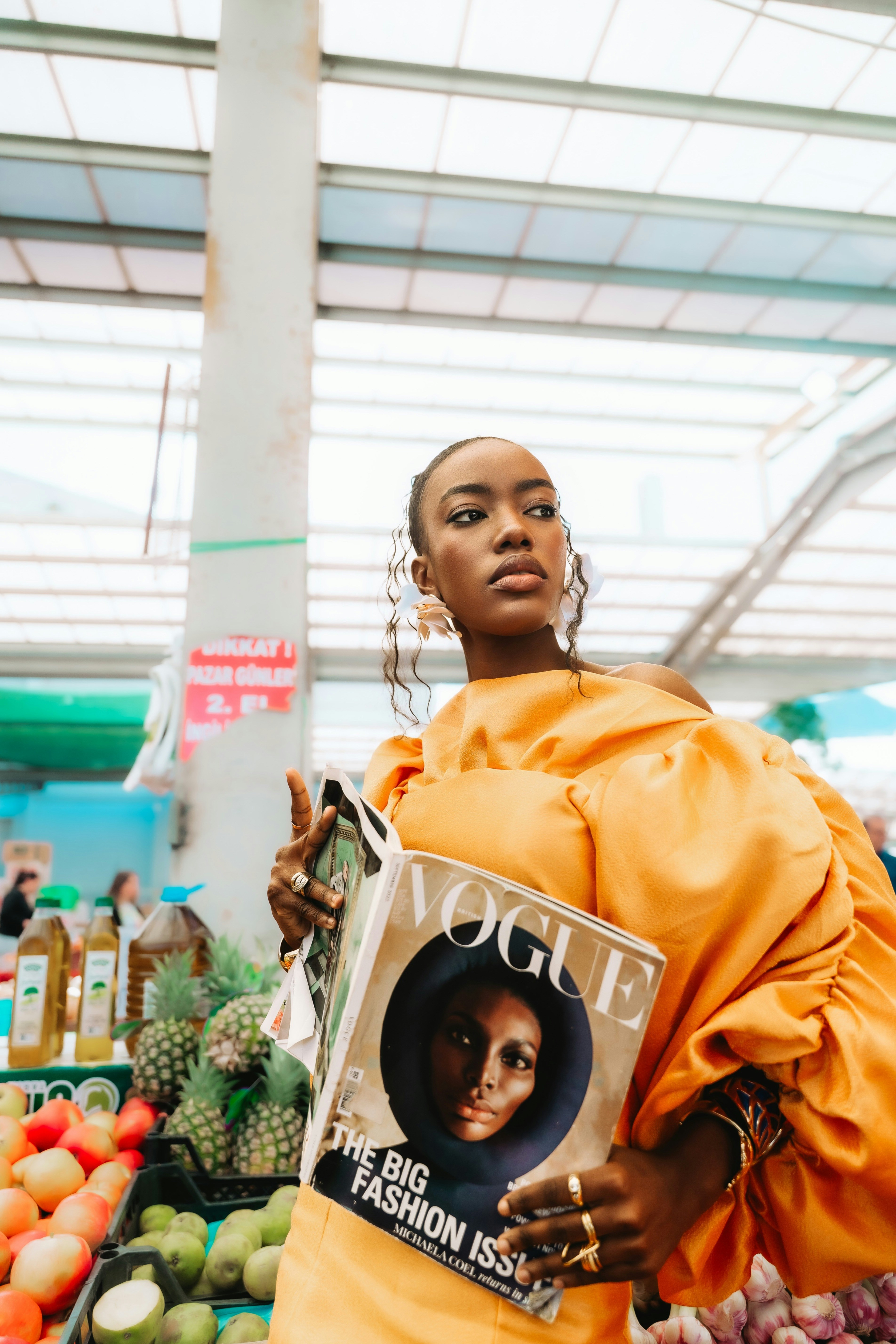 Vogue at the Market: A Bold Orange Silhouette Grips a Fashion Magazine