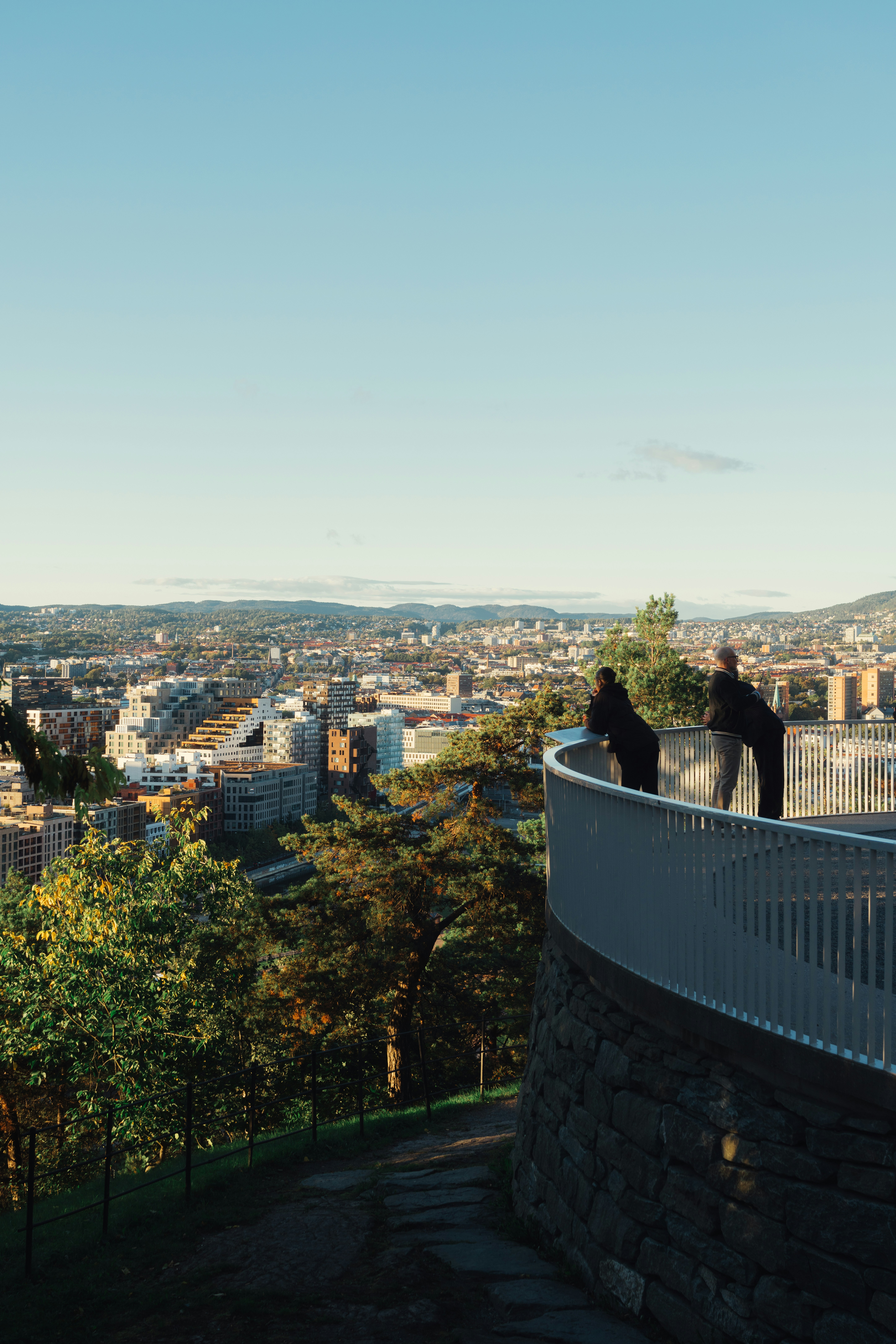 Vista Overlook: Guardians on the Ramp, City Unfolding Beneath