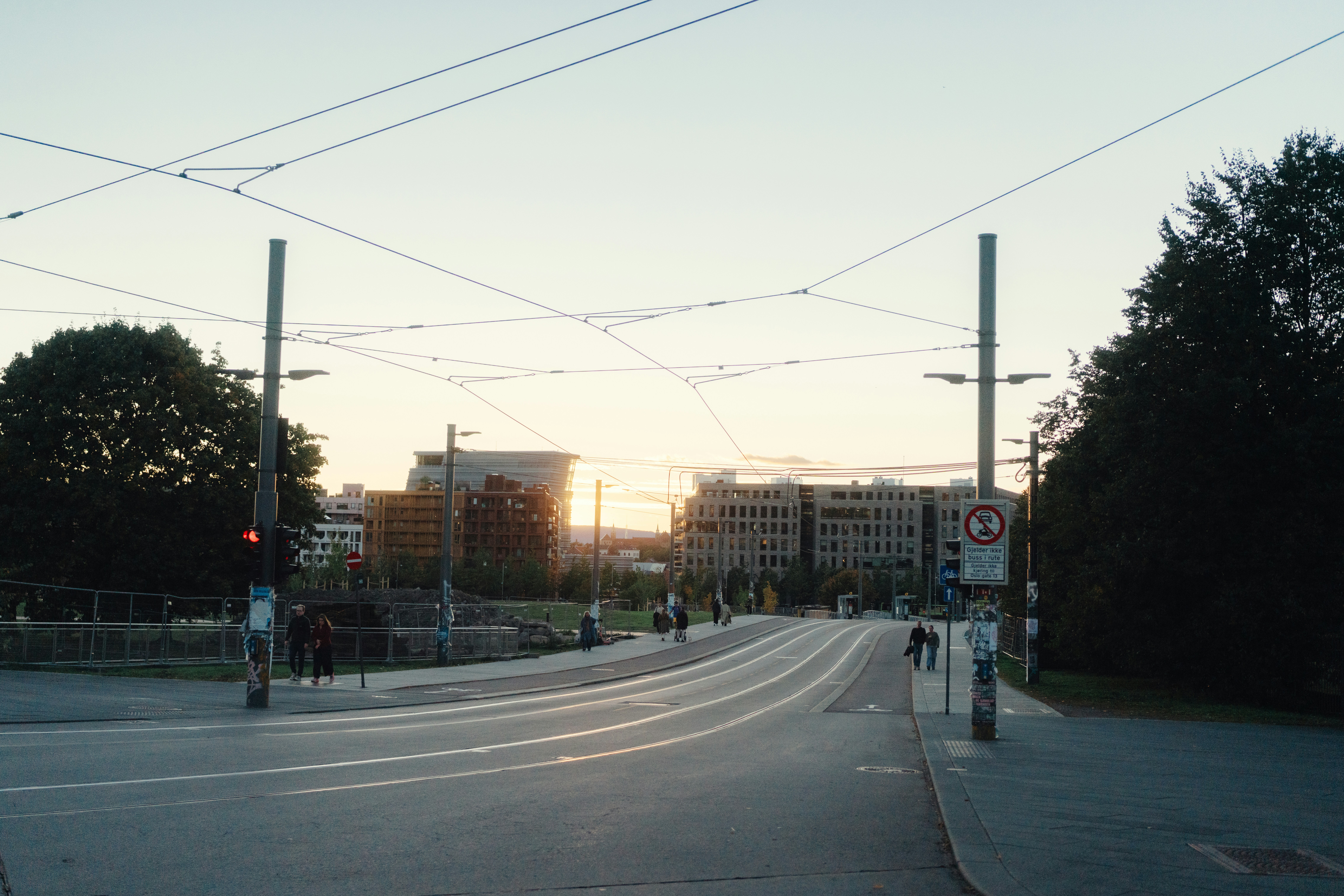 Sunlit Boulevard: Crossing Toward a Quiet City at Dusk