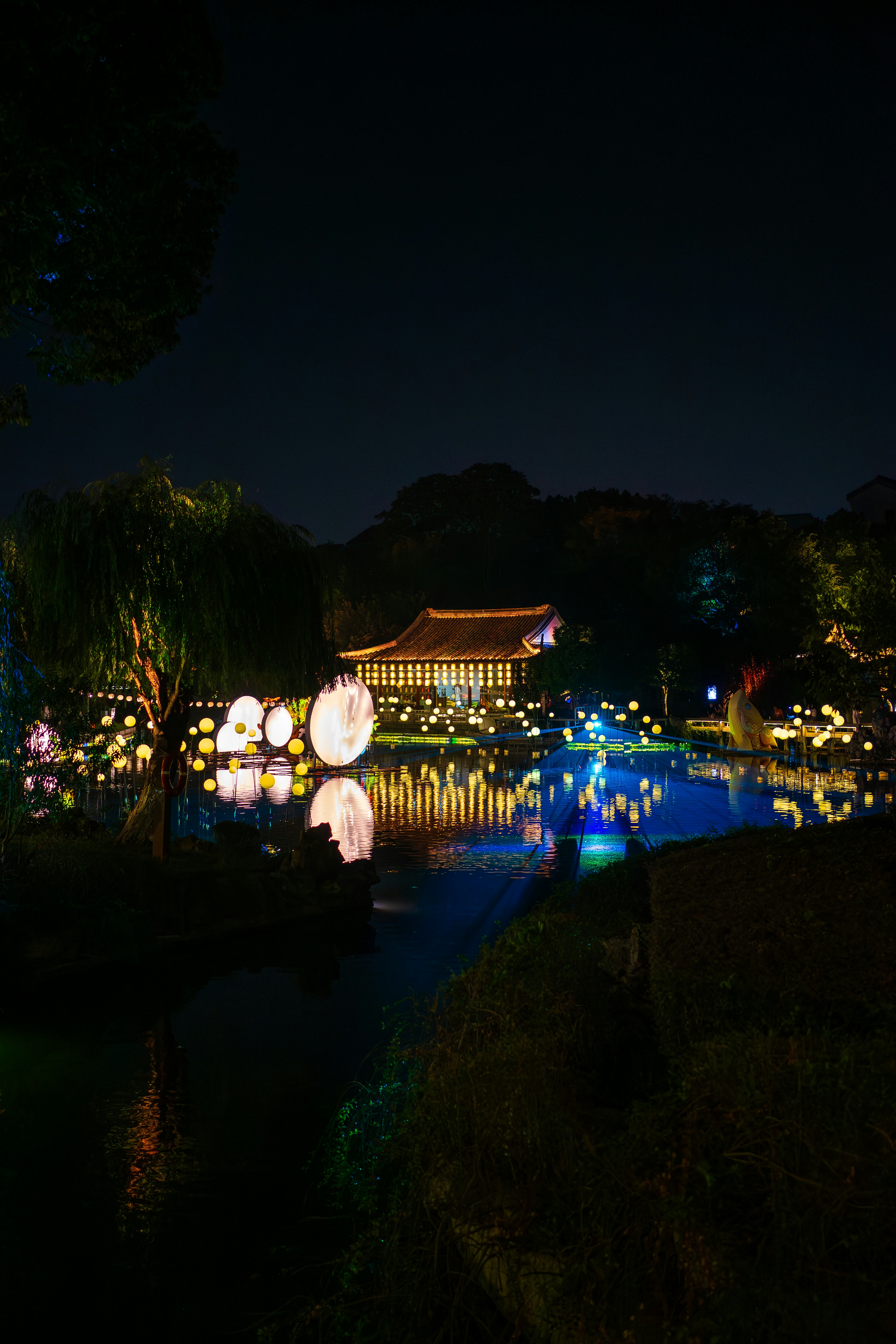 Lantern Reflections Over a Silent Waterway