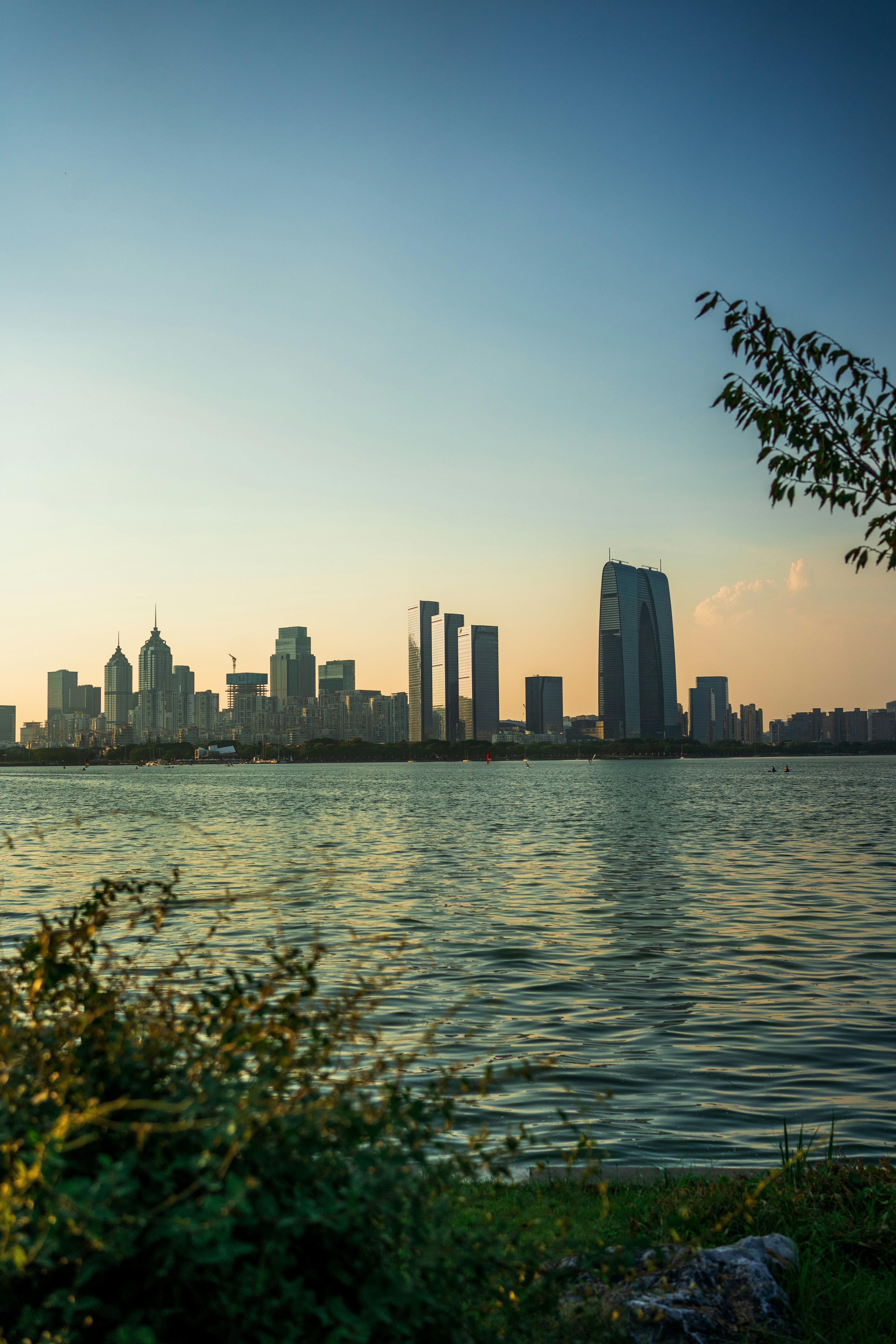 Dawn over Glassy Waters: Shanghai Skyline at Sundown
