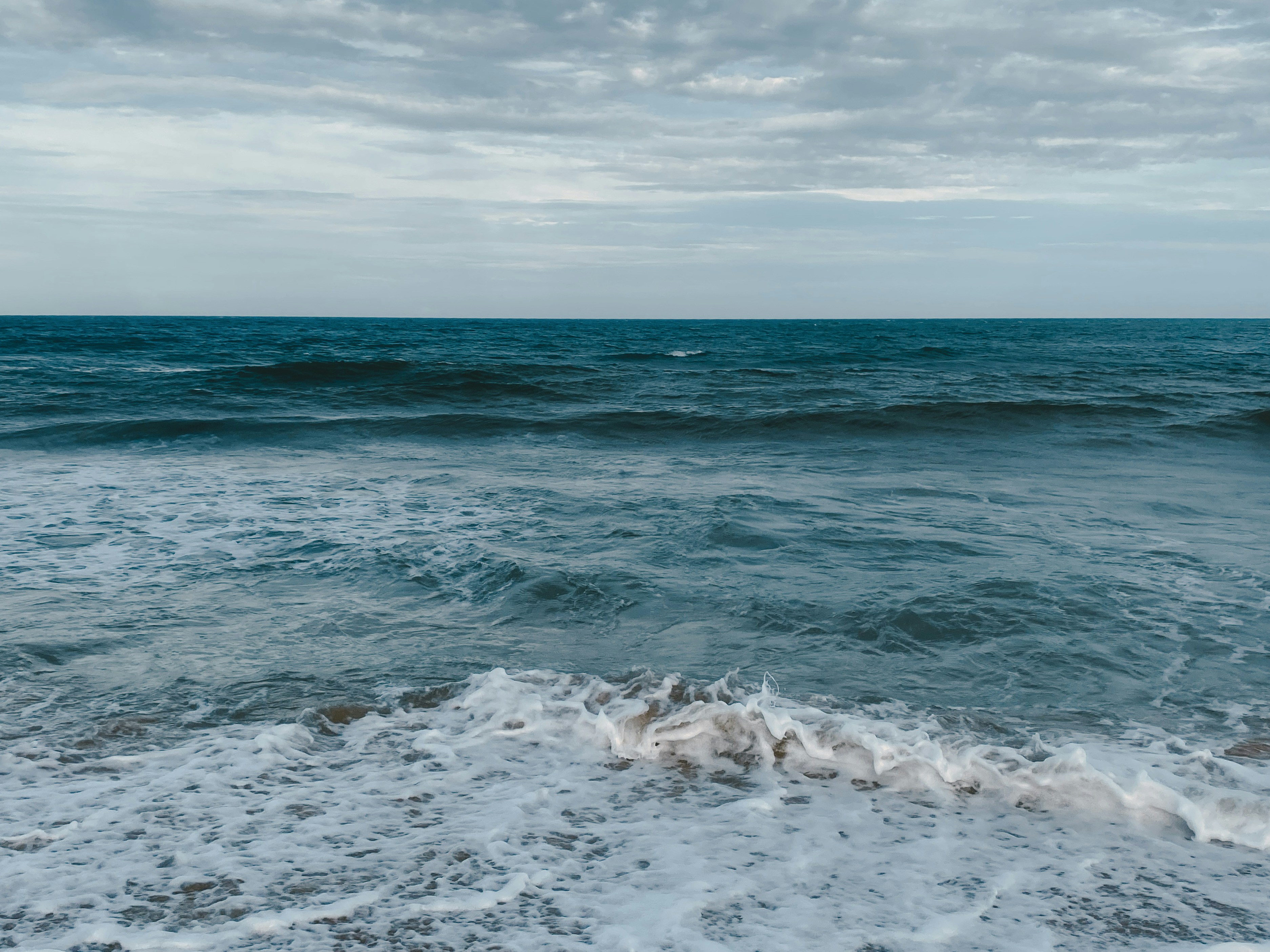 Horizon Breach: A Quiet Sea Under Patchy Clouds