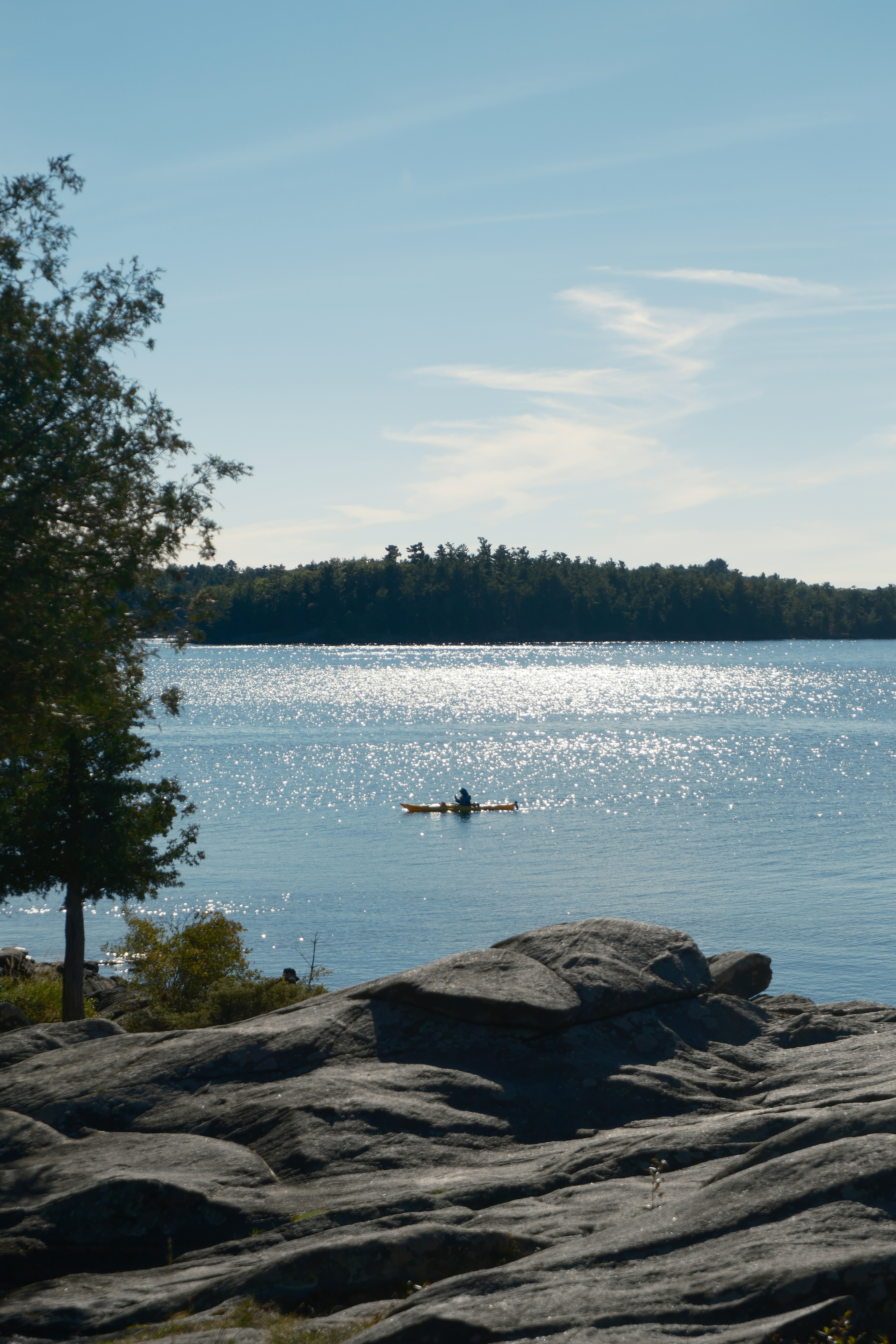 Sunlit Rowboat on a Quiet Lake at Dusk Reflecting Gentle Sparkles