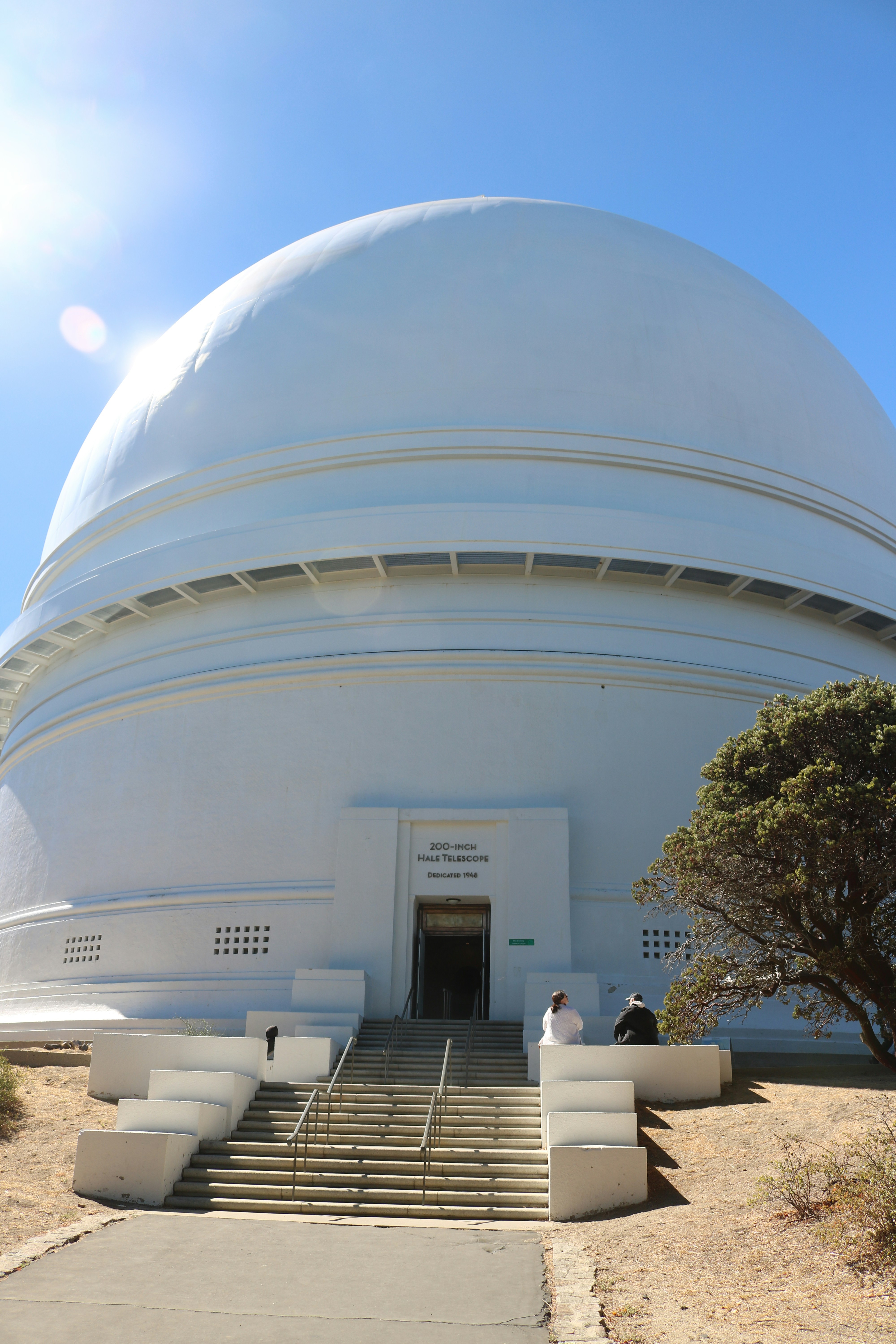White dome under a bright blue sky at the observatory