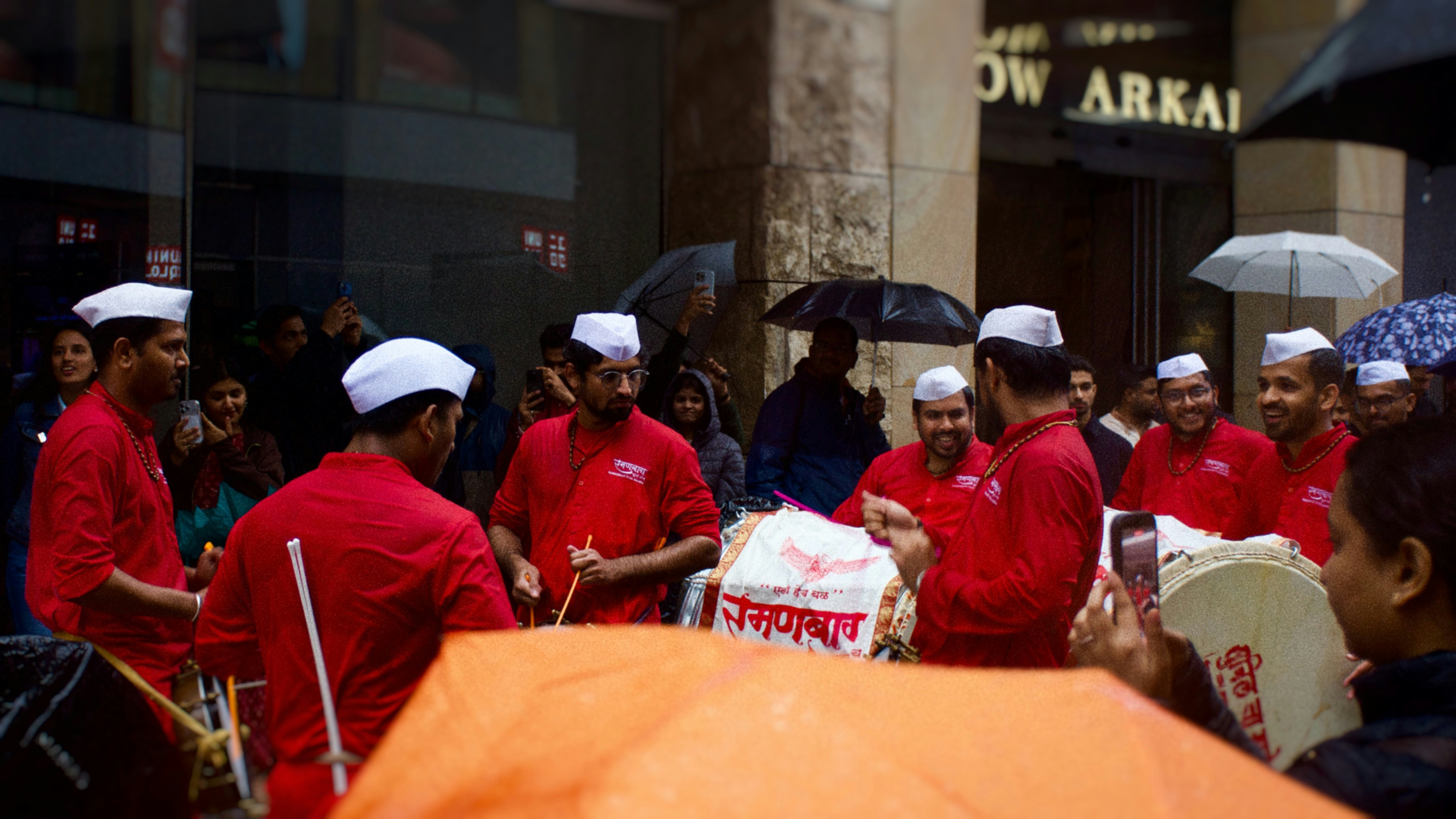Red-robed parade under a gray drizzle