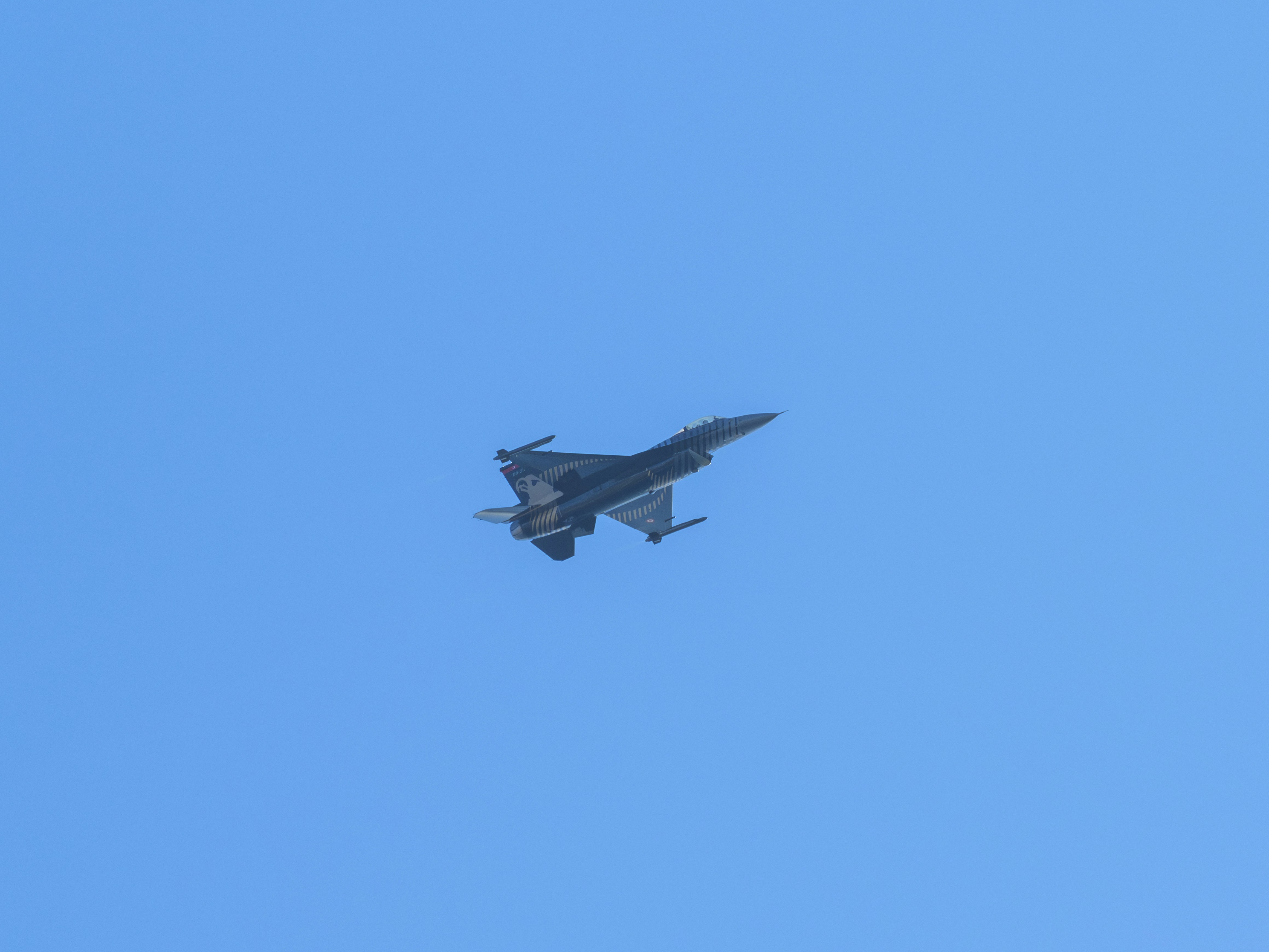 Aircraft slice through a clear blue expanse
