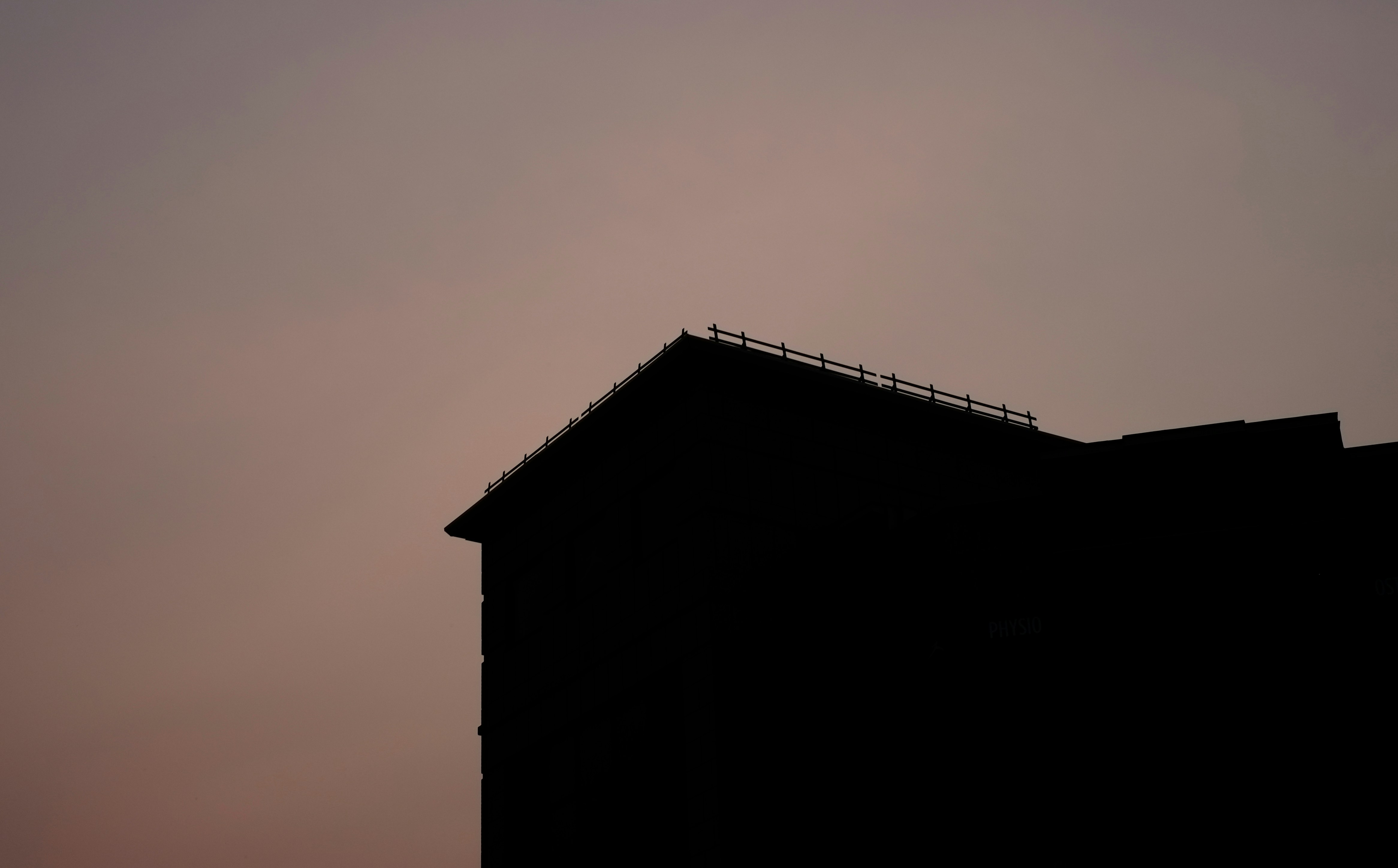 Silhouette at Dusk: Roofline Against a Quiet Sky