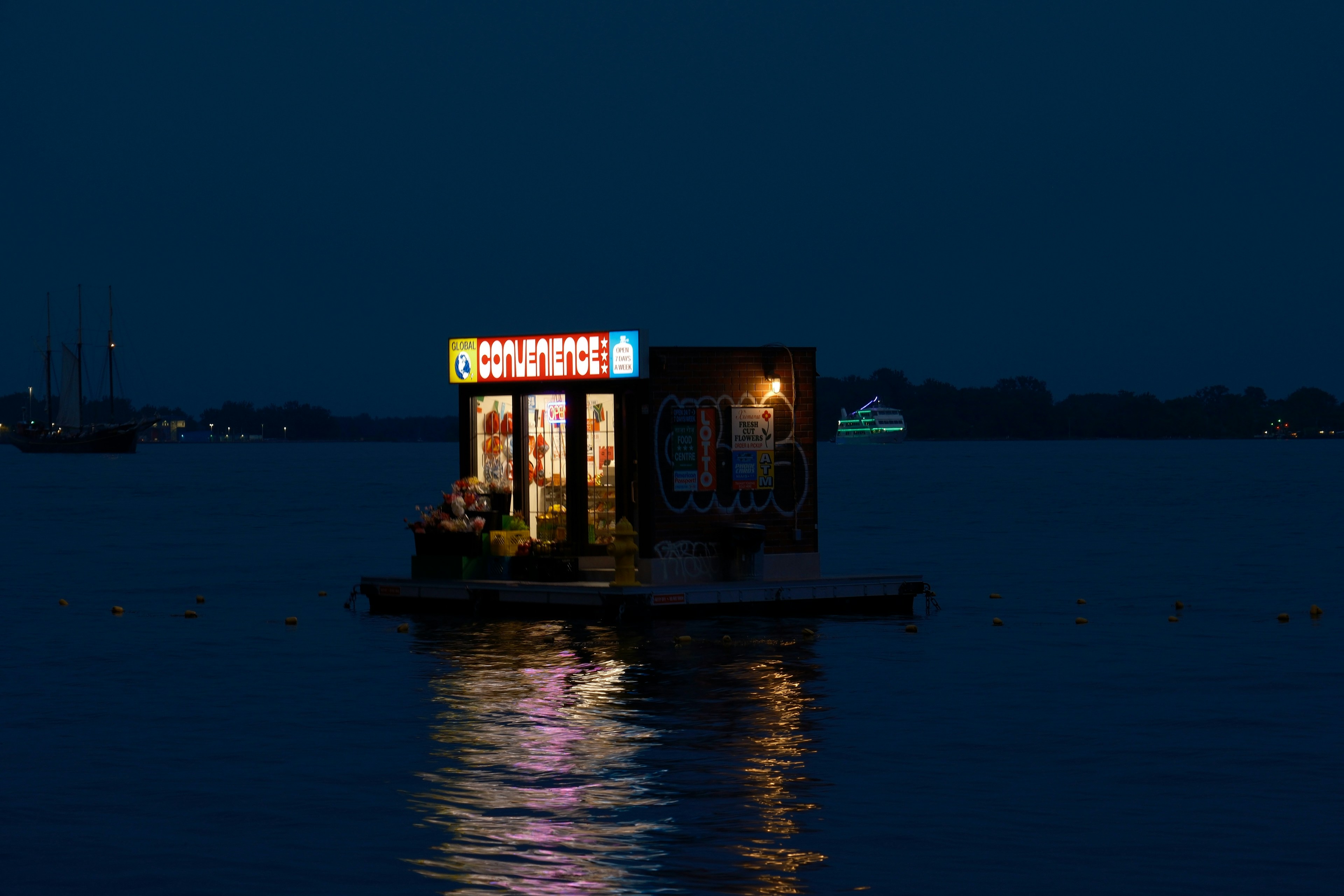 Floating Snack Bar on Still Water at Night