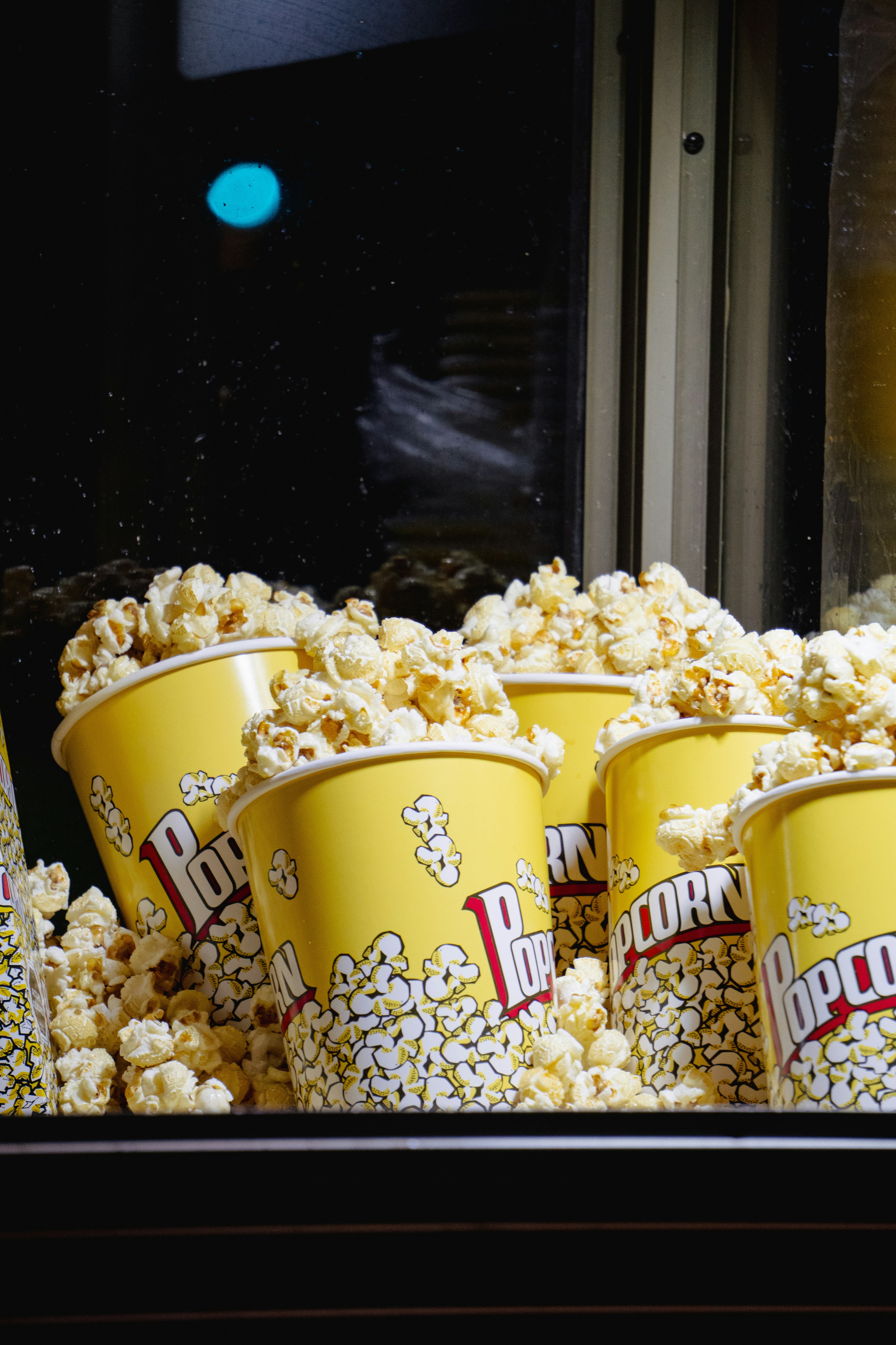Yellow Popcorn Cups Crowd the Vitrine Window