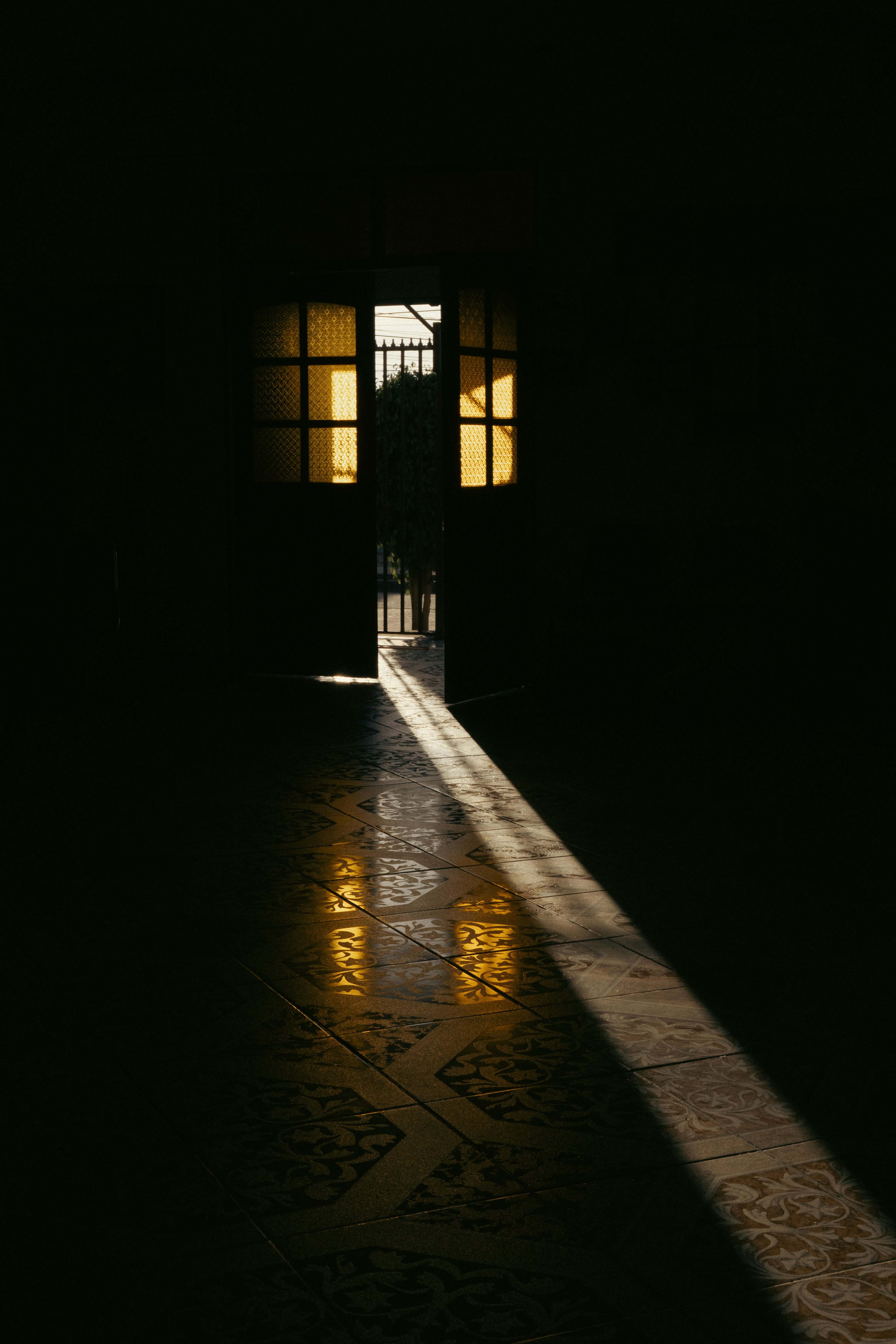 Golden Threshold: Light Slashes Across a Quiet Interior