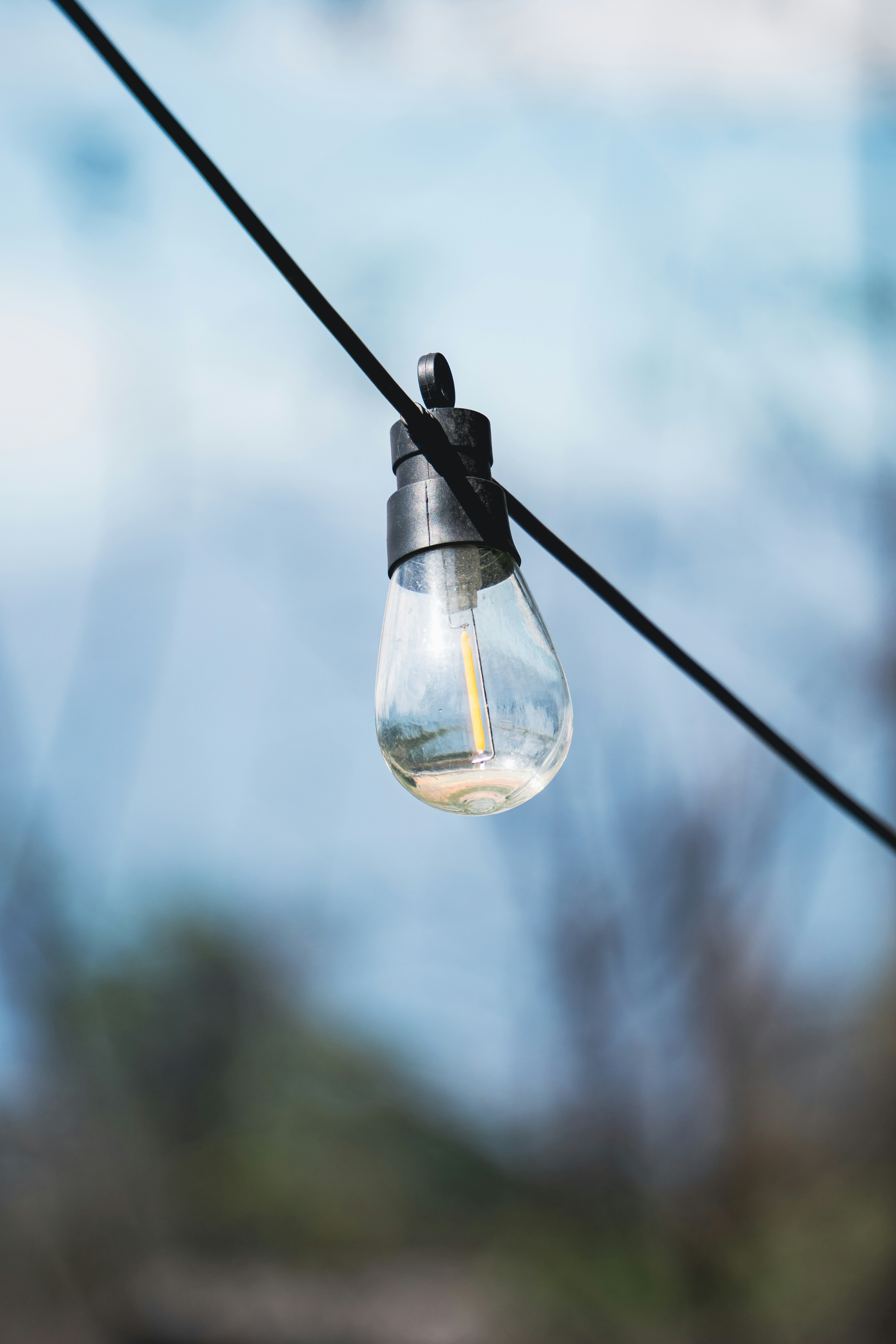 A Lone Bulb on a Tightline: Portrait of a Hanging Light