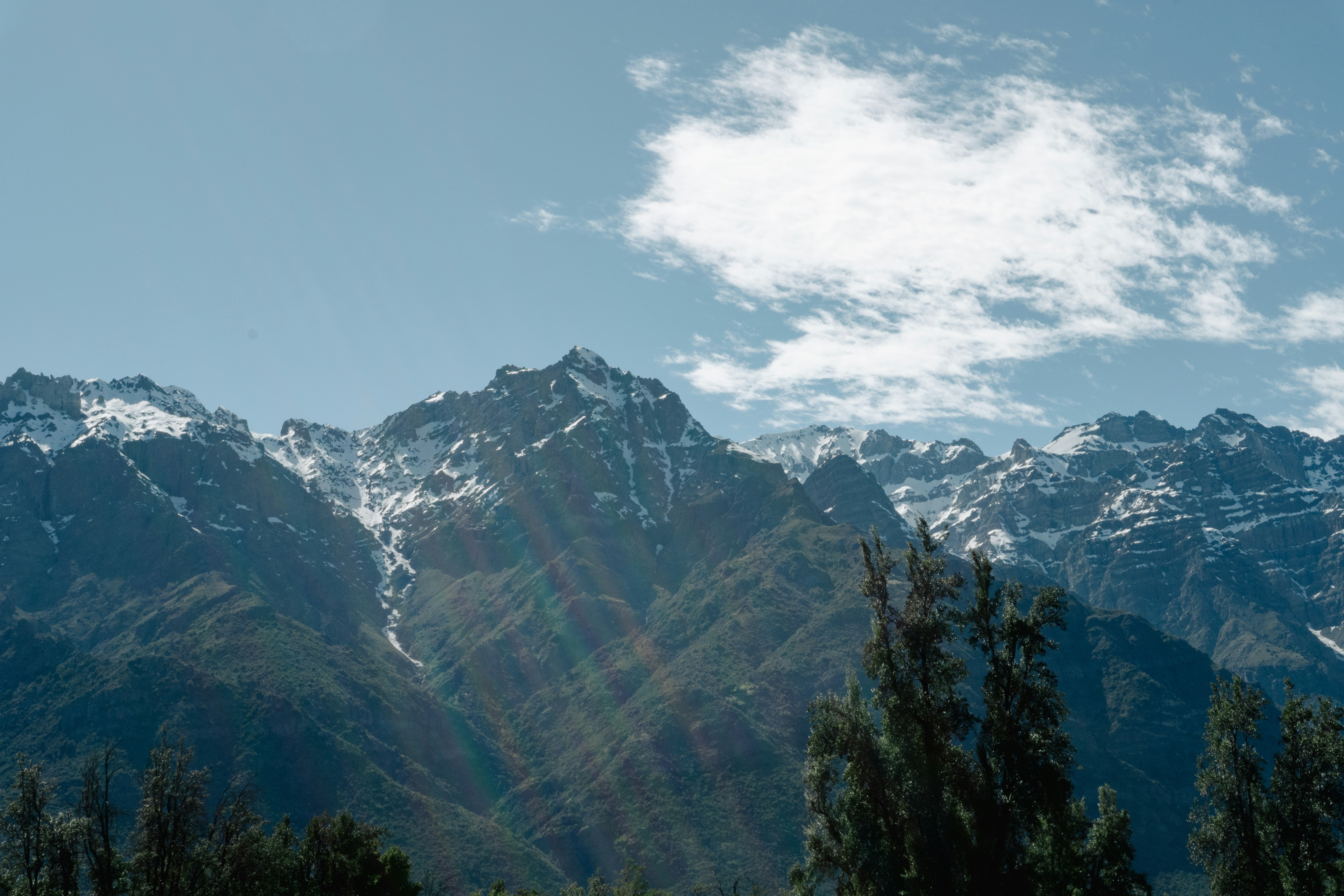 Snow-kissed Ridge Under a Wide Blue Arc