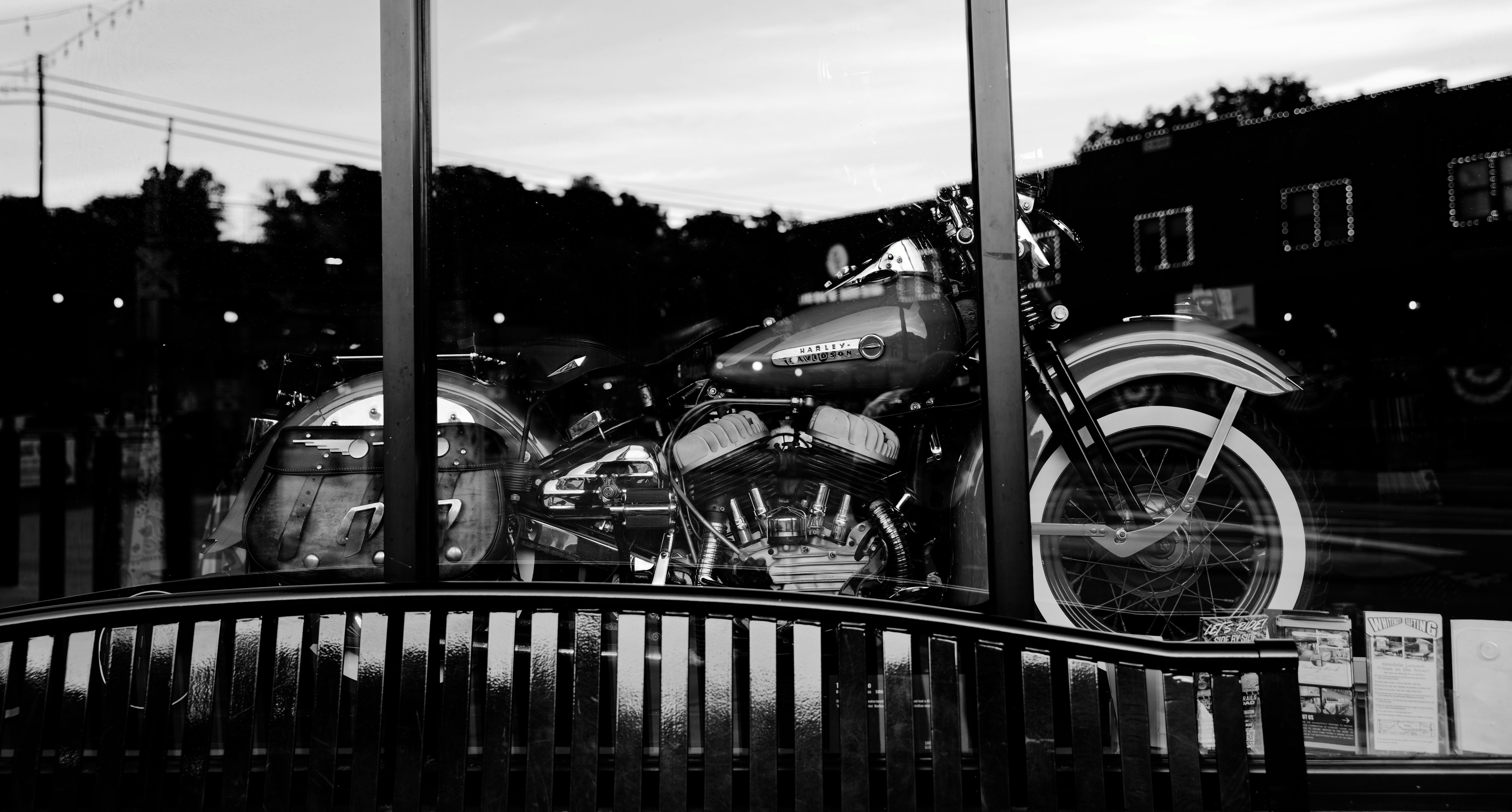 Steel Echoes: A Motorcycle Silhouette in a Glass Shopfront