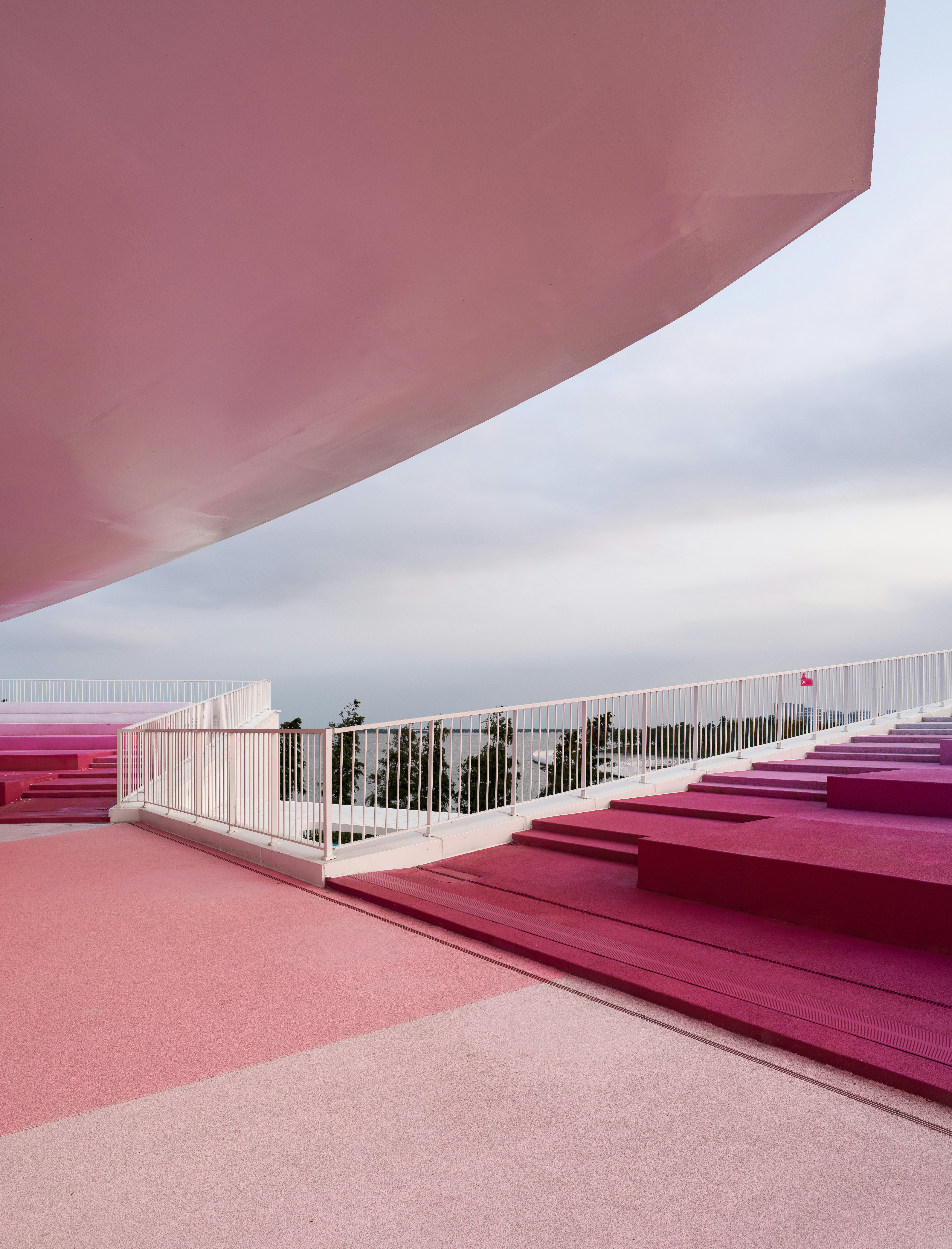 Pink Concrete Steps Beneath a Sculpted Overhang