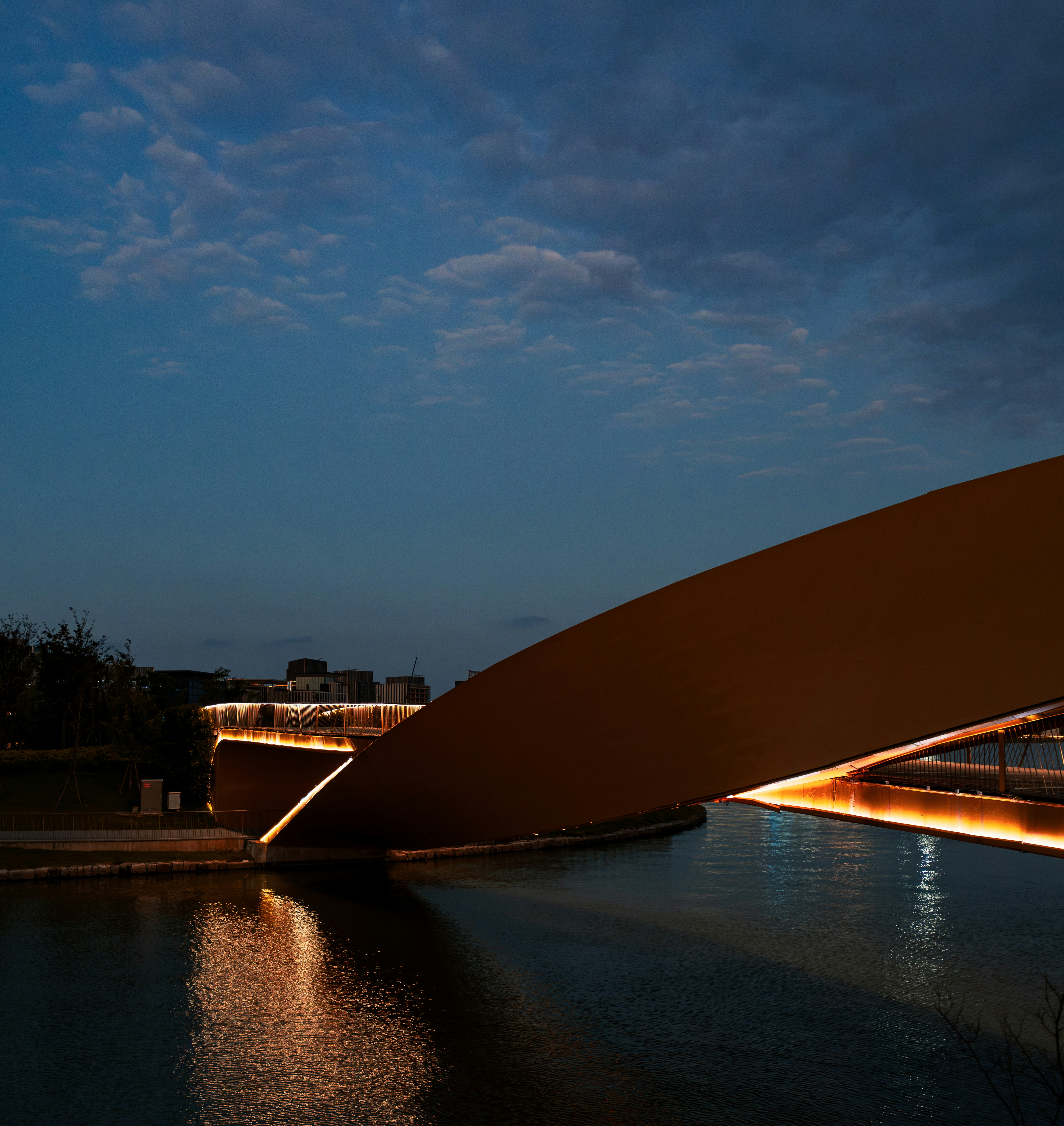 Golden Arc at Dusk: A Quiet Bridge Piercing the Water