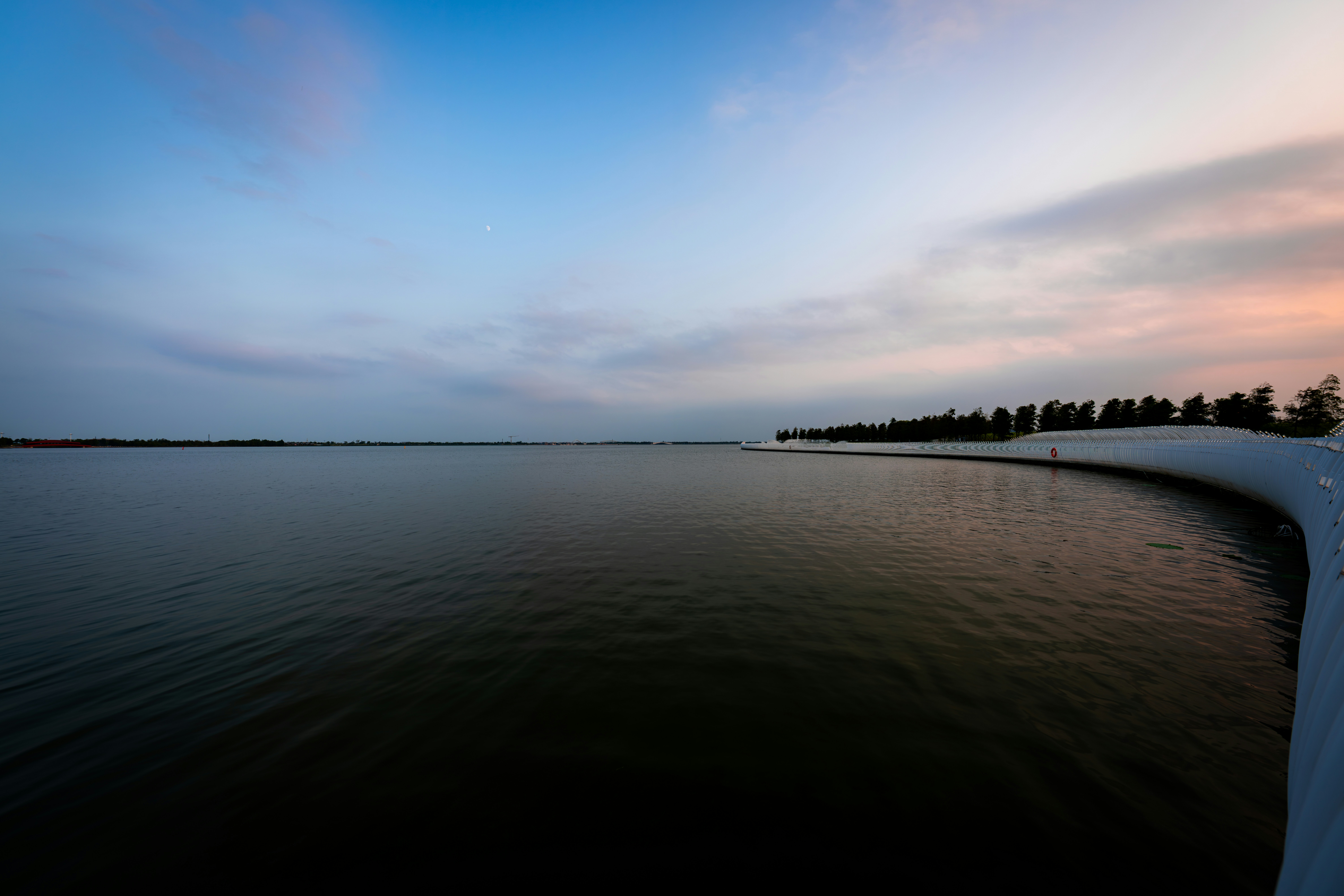 Dawn Over the Quiet Lake: A Gentle Bow of Water and Sky