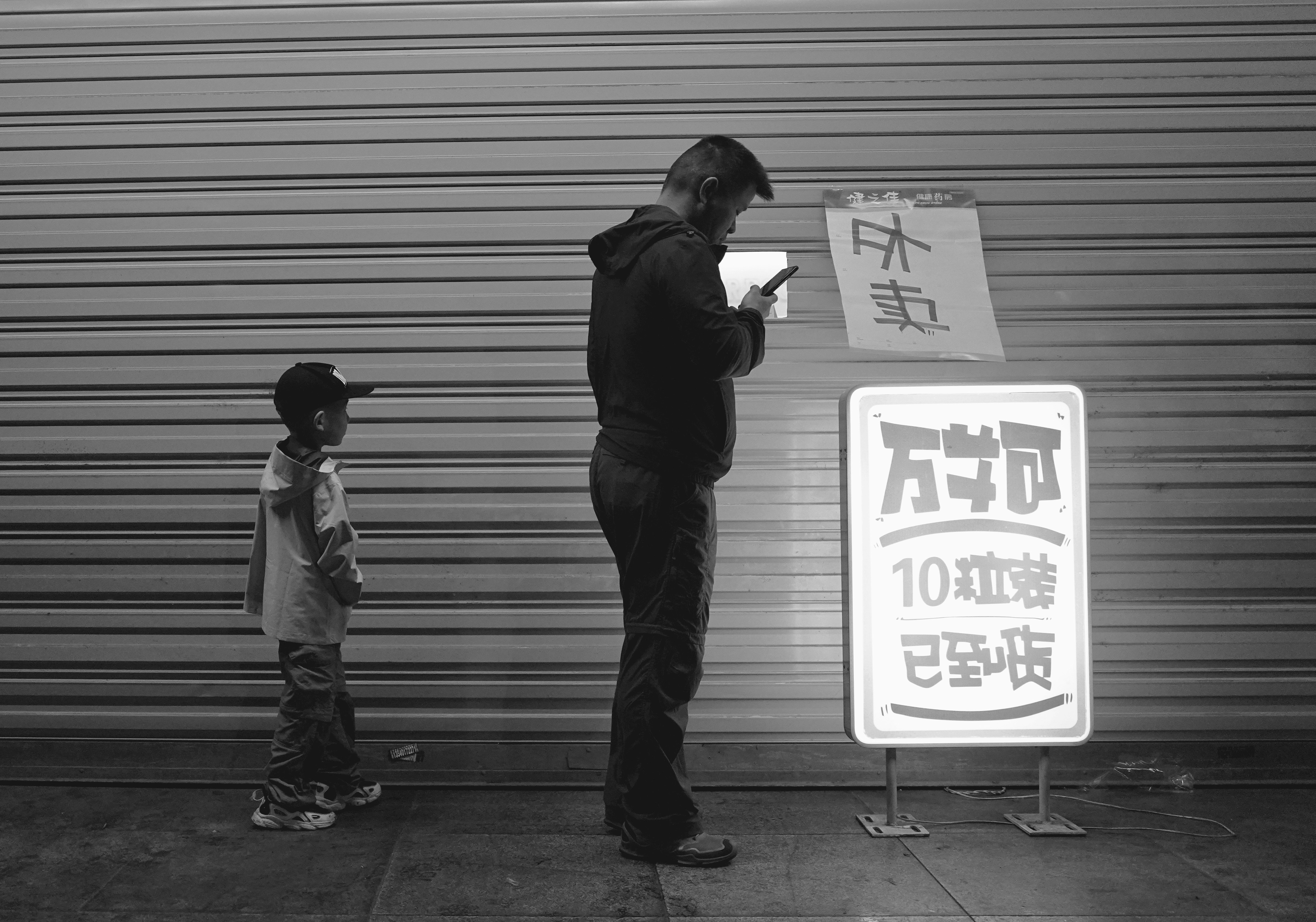 Silhouette of Focus: A Thinker and a Young Observer by Neon Sign