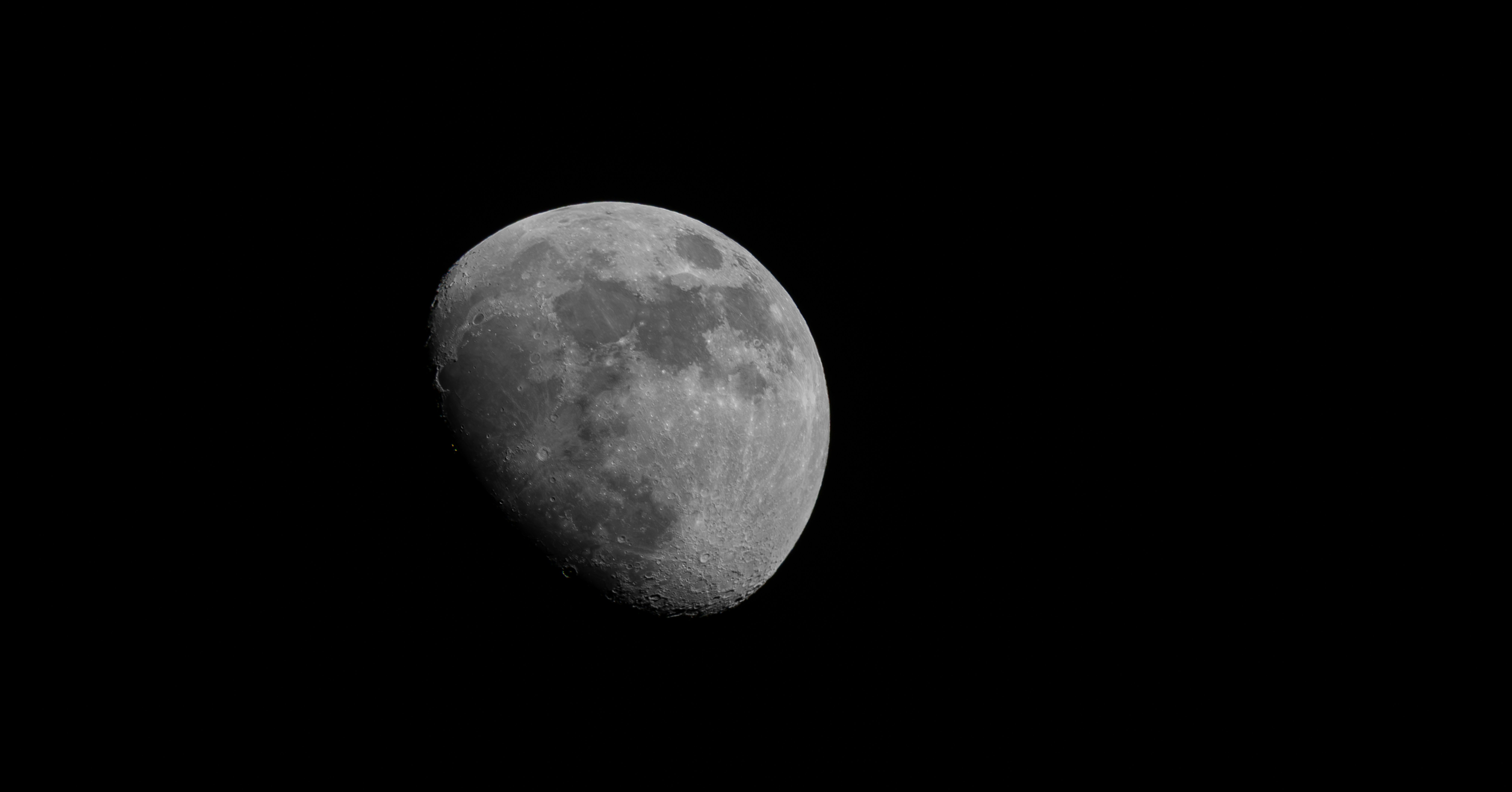 Slim crescent moon against a void of space, softly illuminated lunar maria and craters visible; suitable for astronomy or night-sky lighting study.