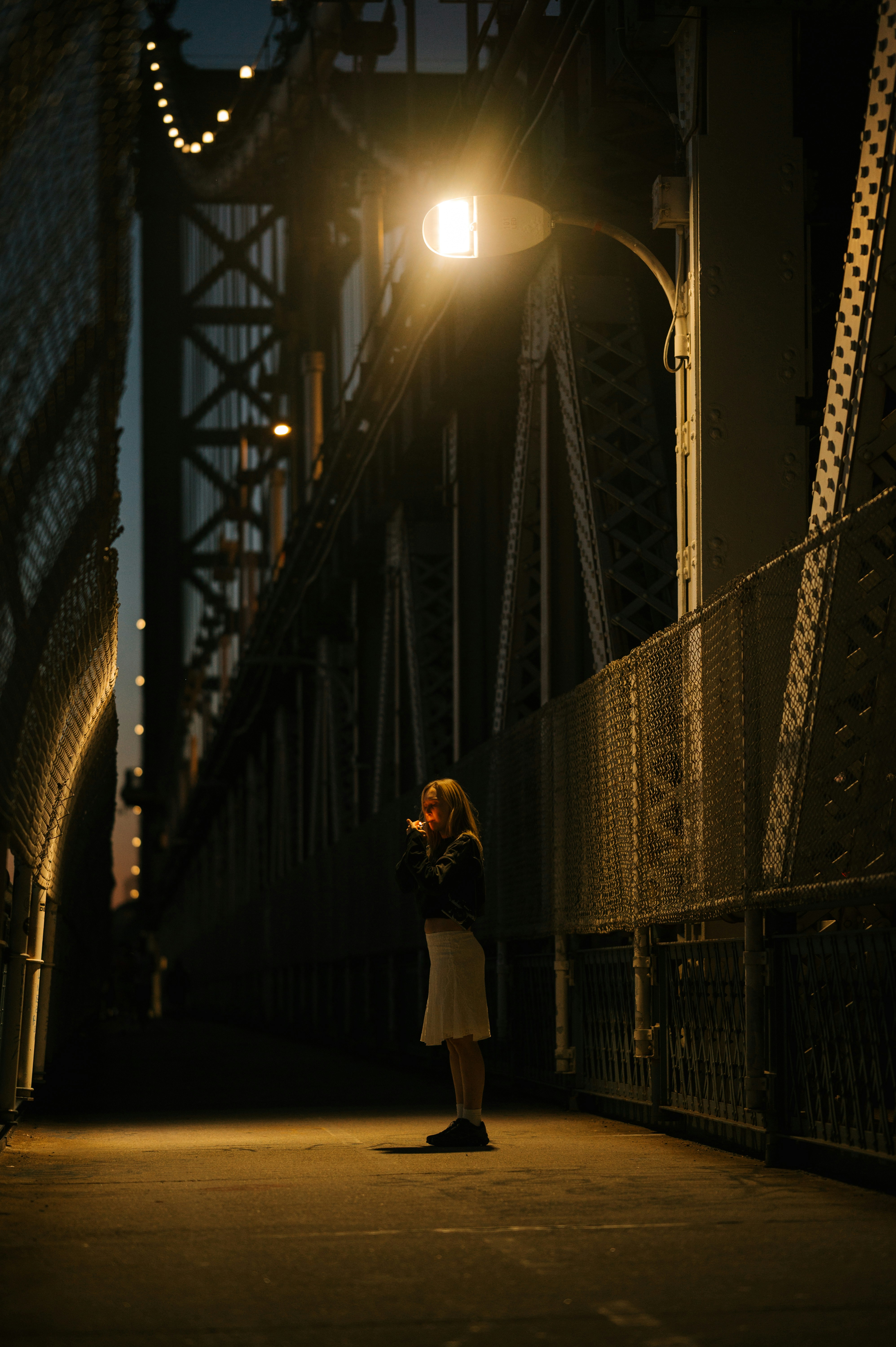 Midnight Vigil on the Bridge: A Quiet Figure Beneath Streetlight