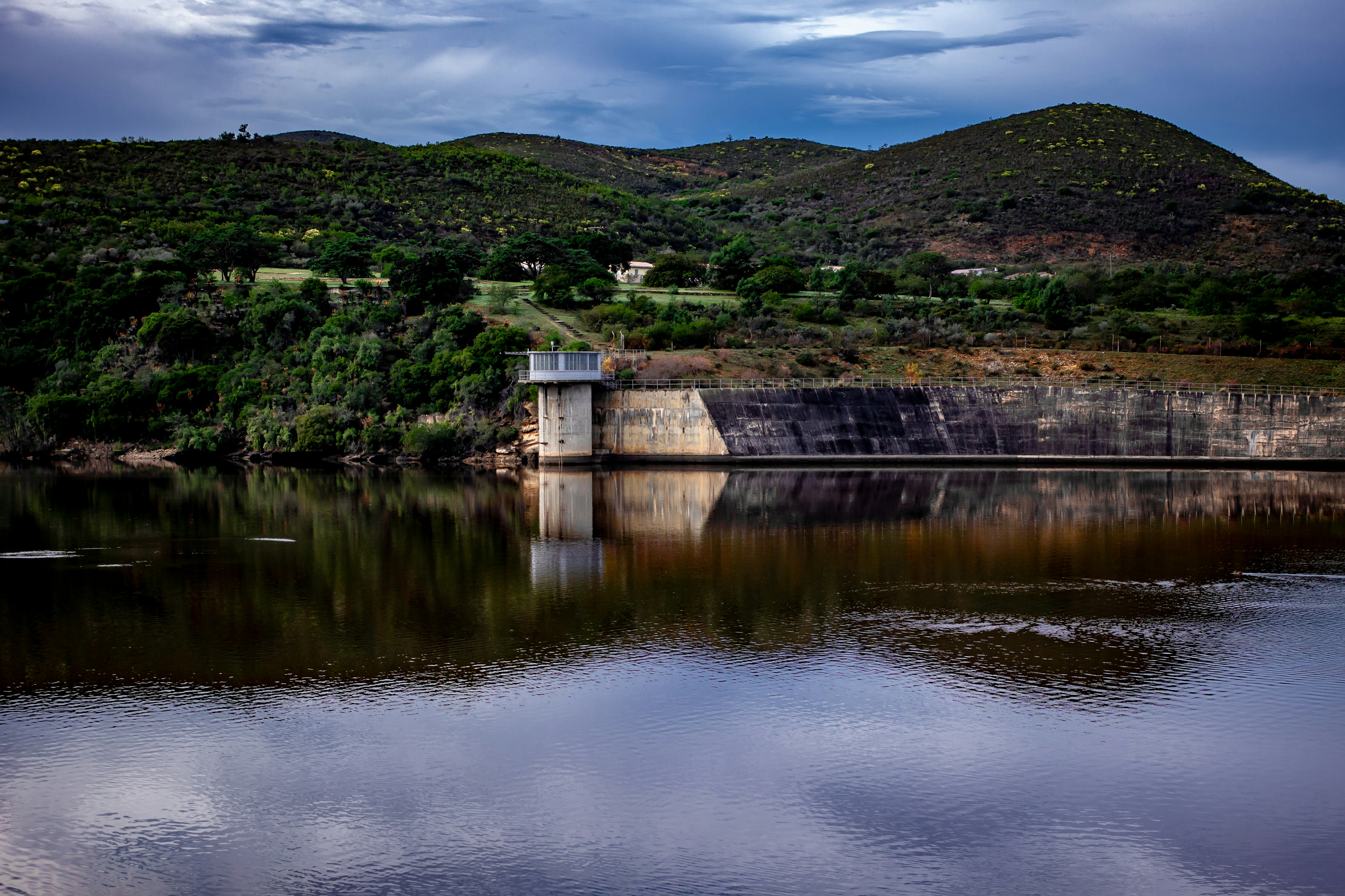 Verdant Hills and Serene Reservoir Reflected