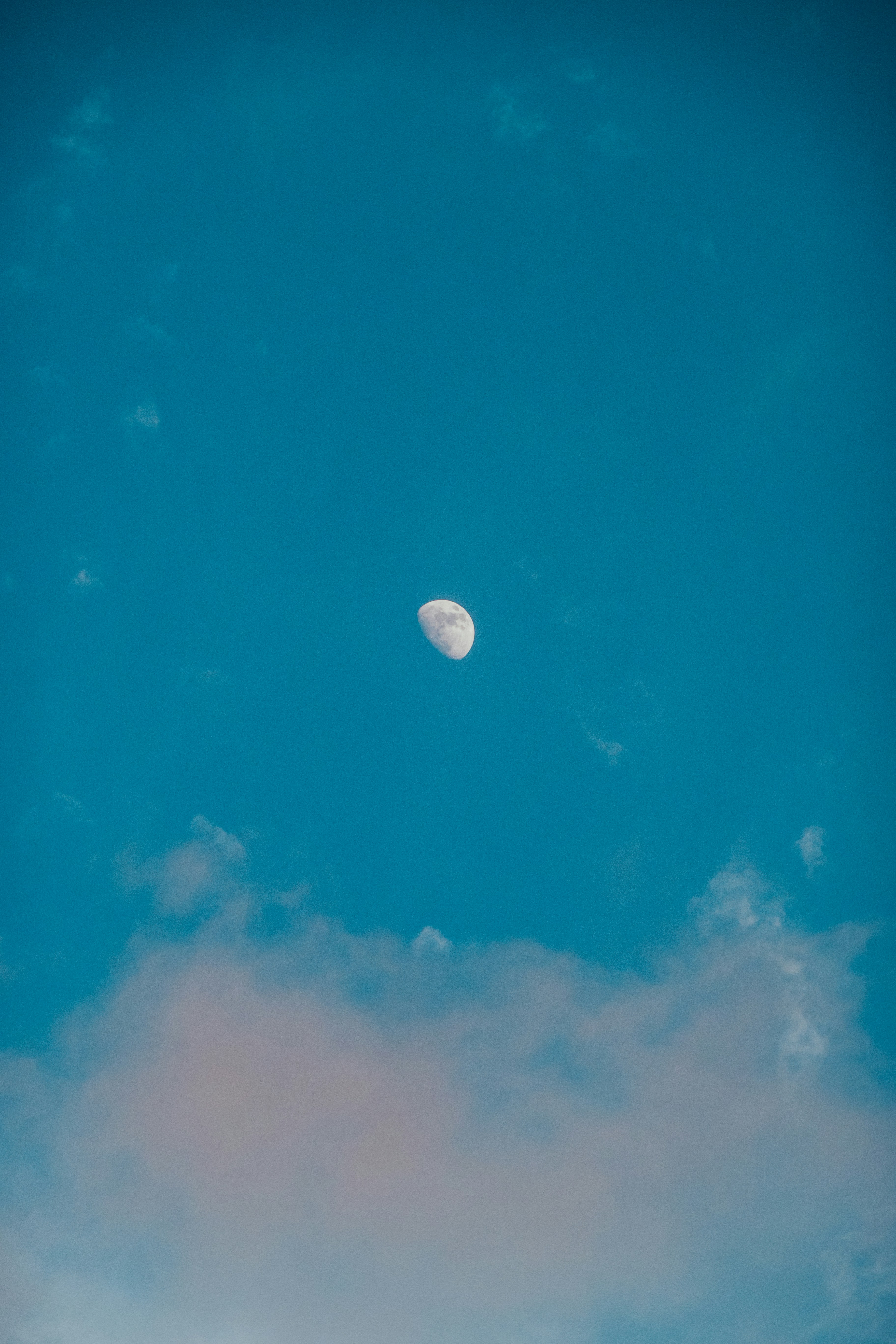 Moon in a Clear Day: A Lone Lunar Crescent Amid Blue Skies