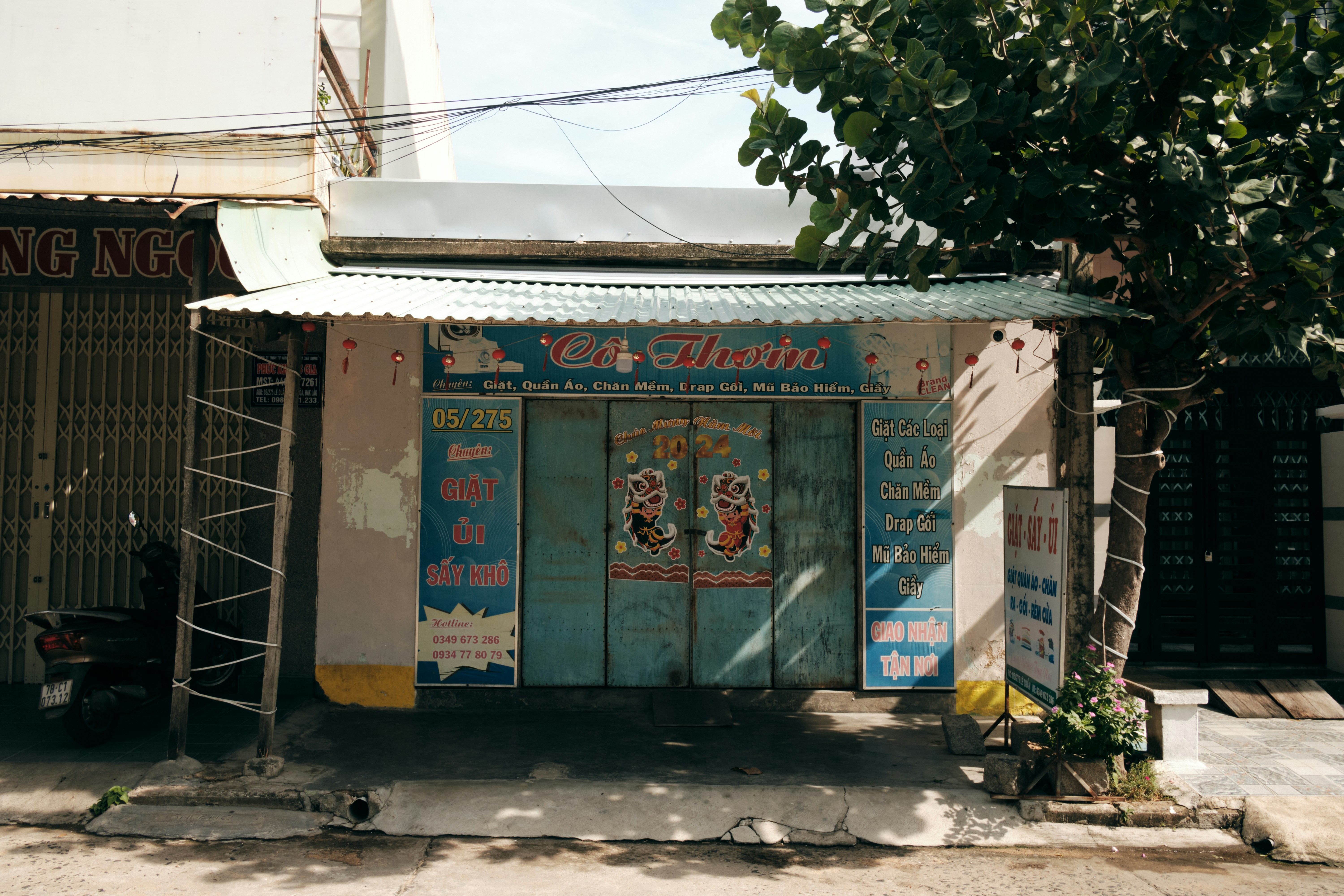 Sunlit Market Facade with Blue Ceramic Doors