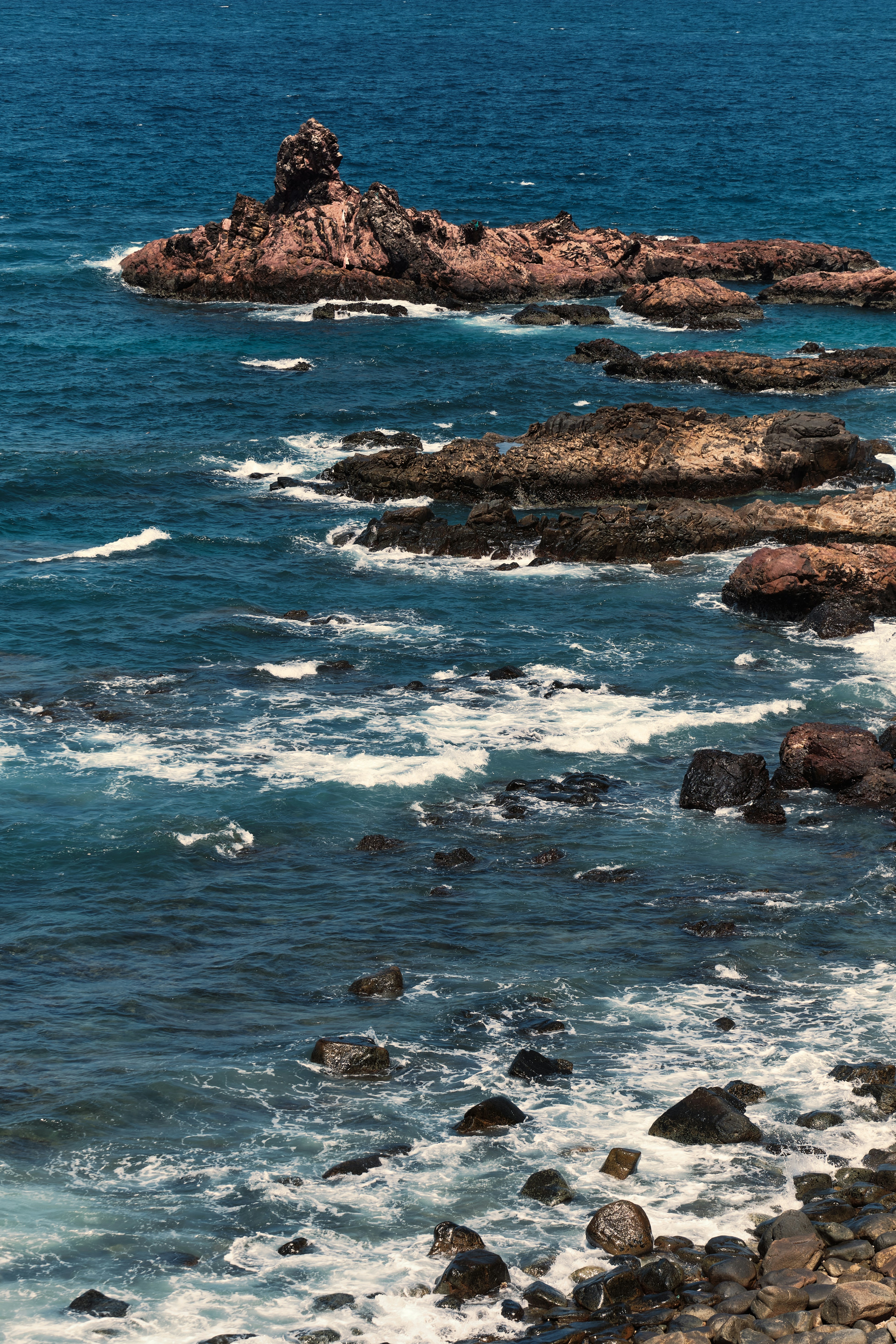 Rocky Outcrop Seabed Edge Under Crown of Blue