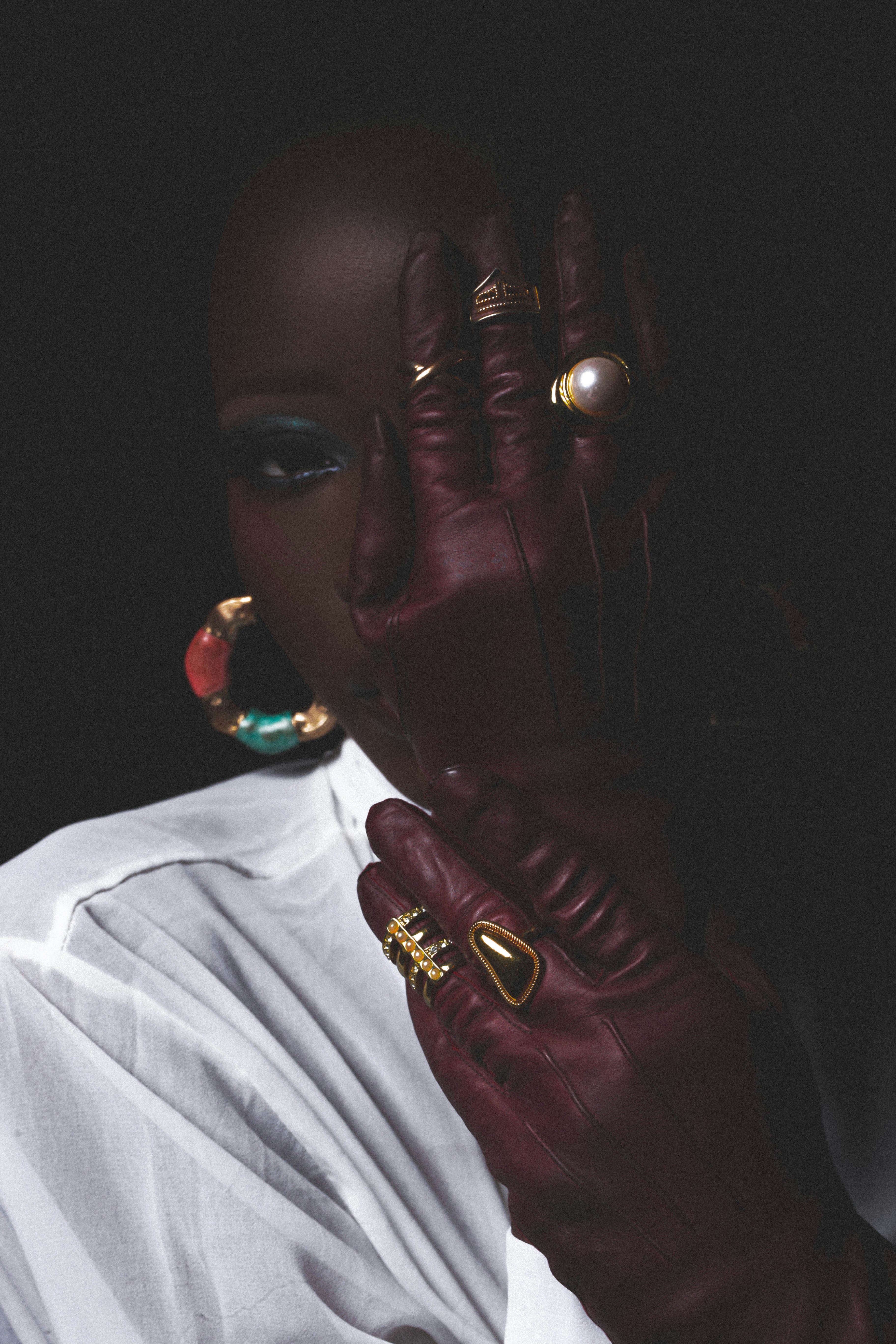 Veiled Glint: Jewelry and Hands in Shadowed Ivory