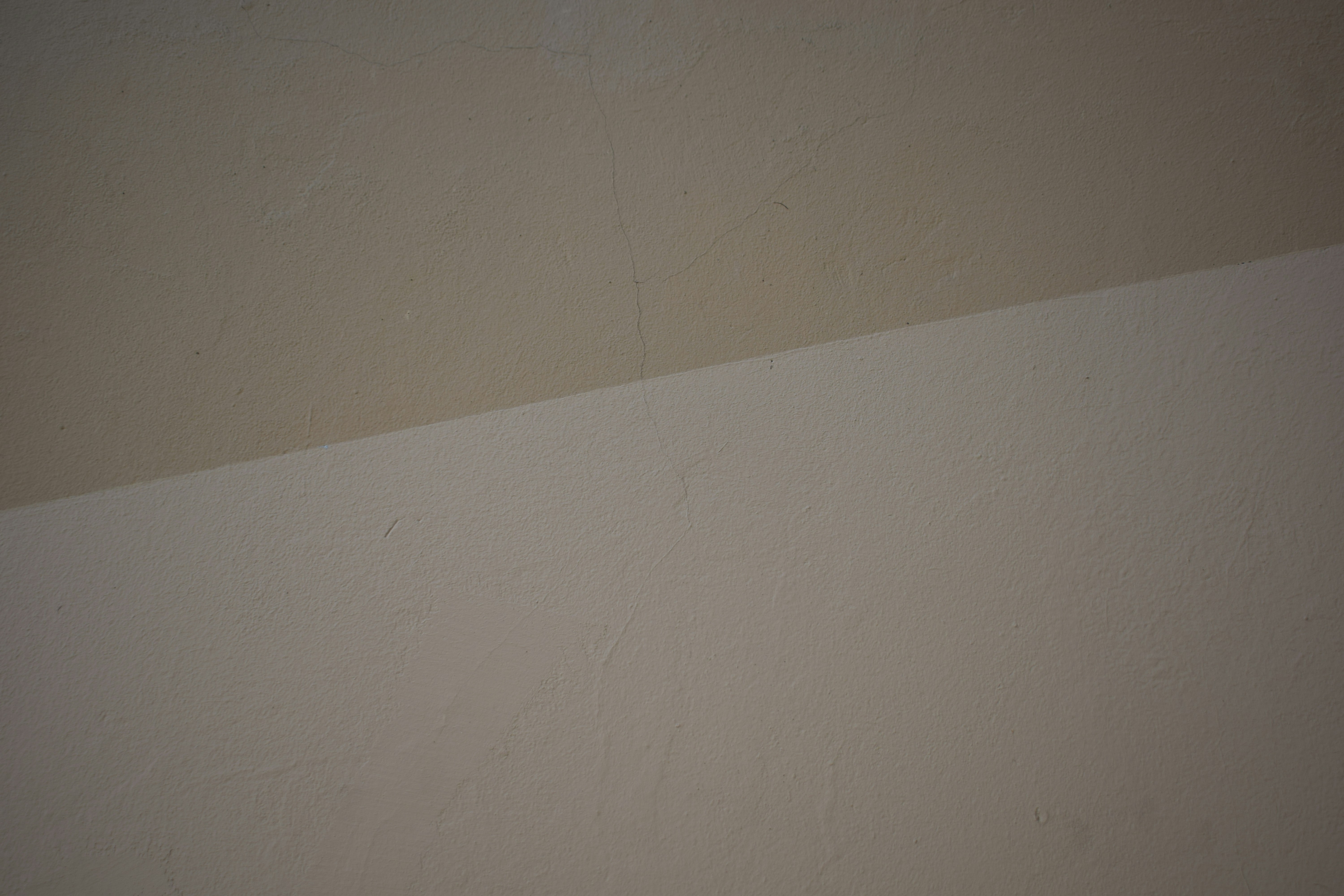 Diagonal Shadow on a Quiet Wall