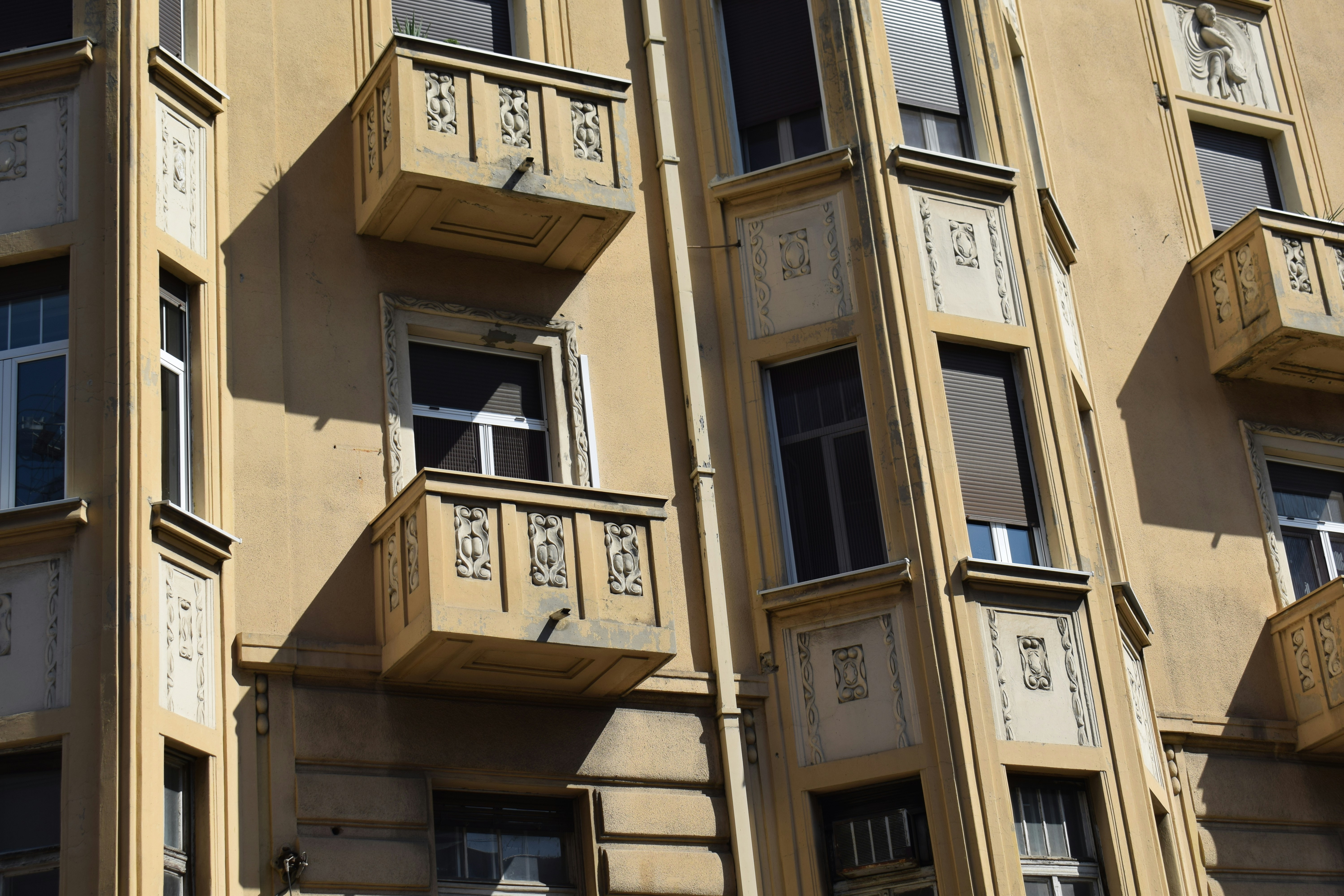 Sunlit Balconies: A Geometric Facade in Warm Urban Light