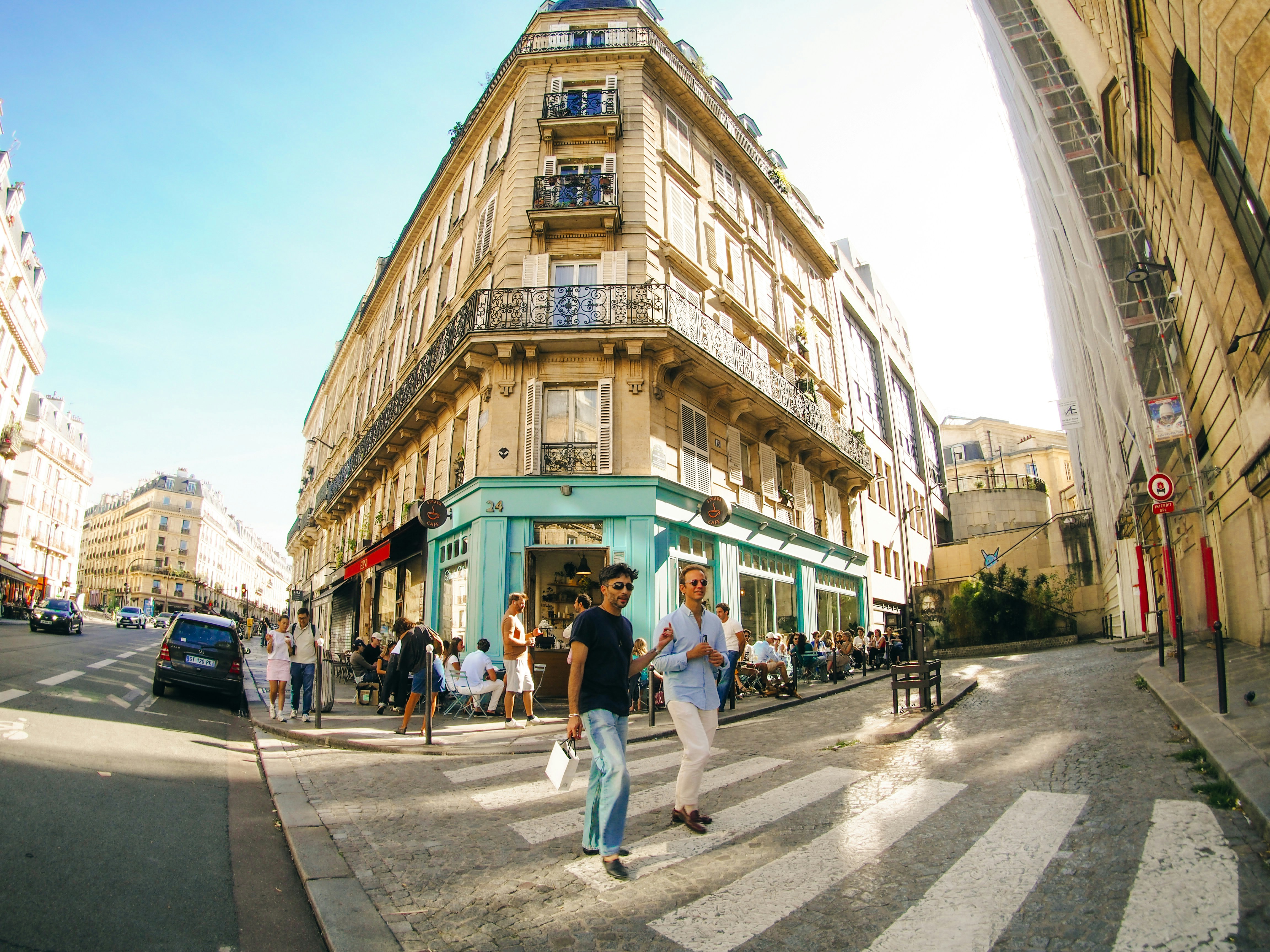 Sunlit corner cafe on a lively Parisian street
