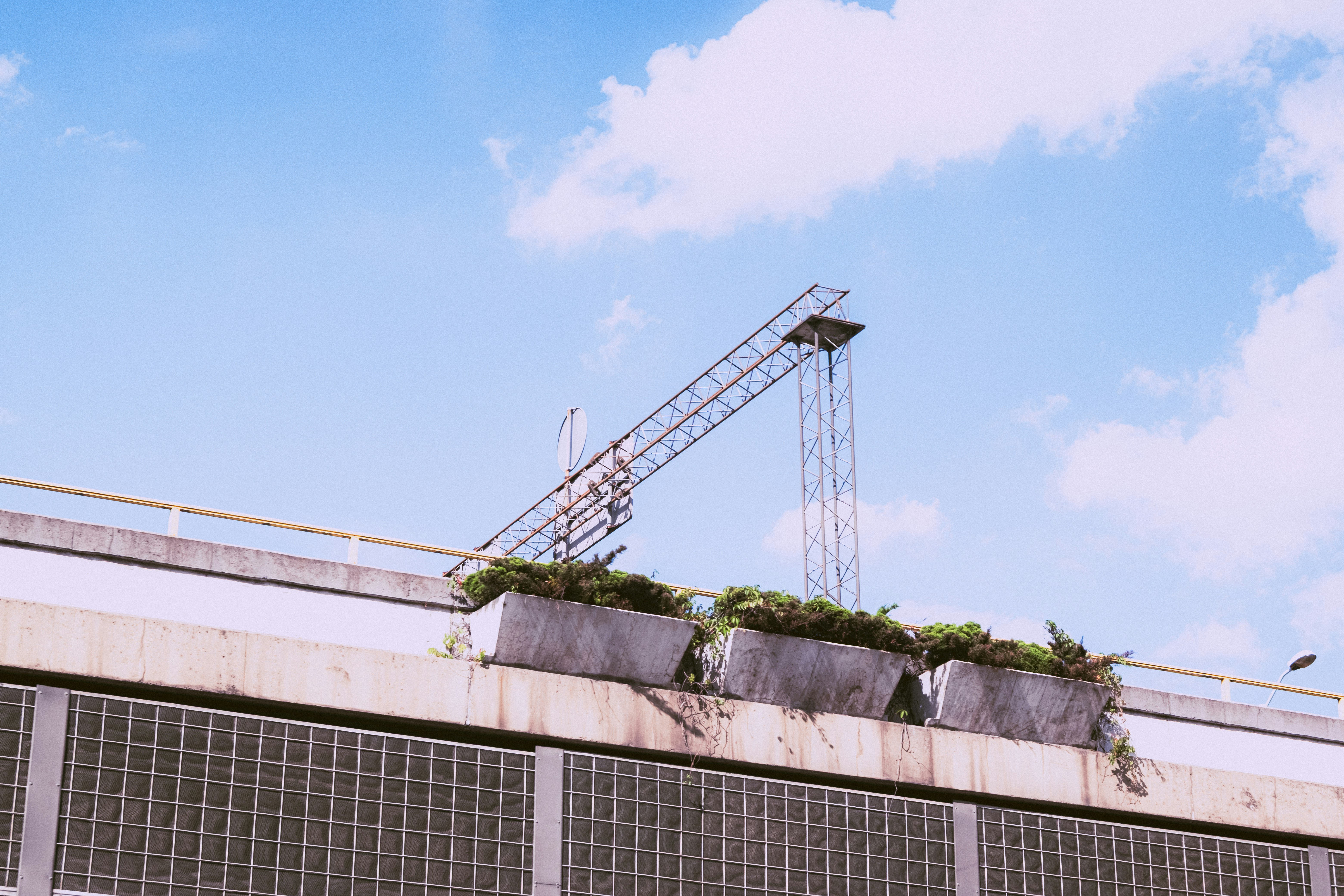 Rooftop Crane Silhouette with Weathered Terraces