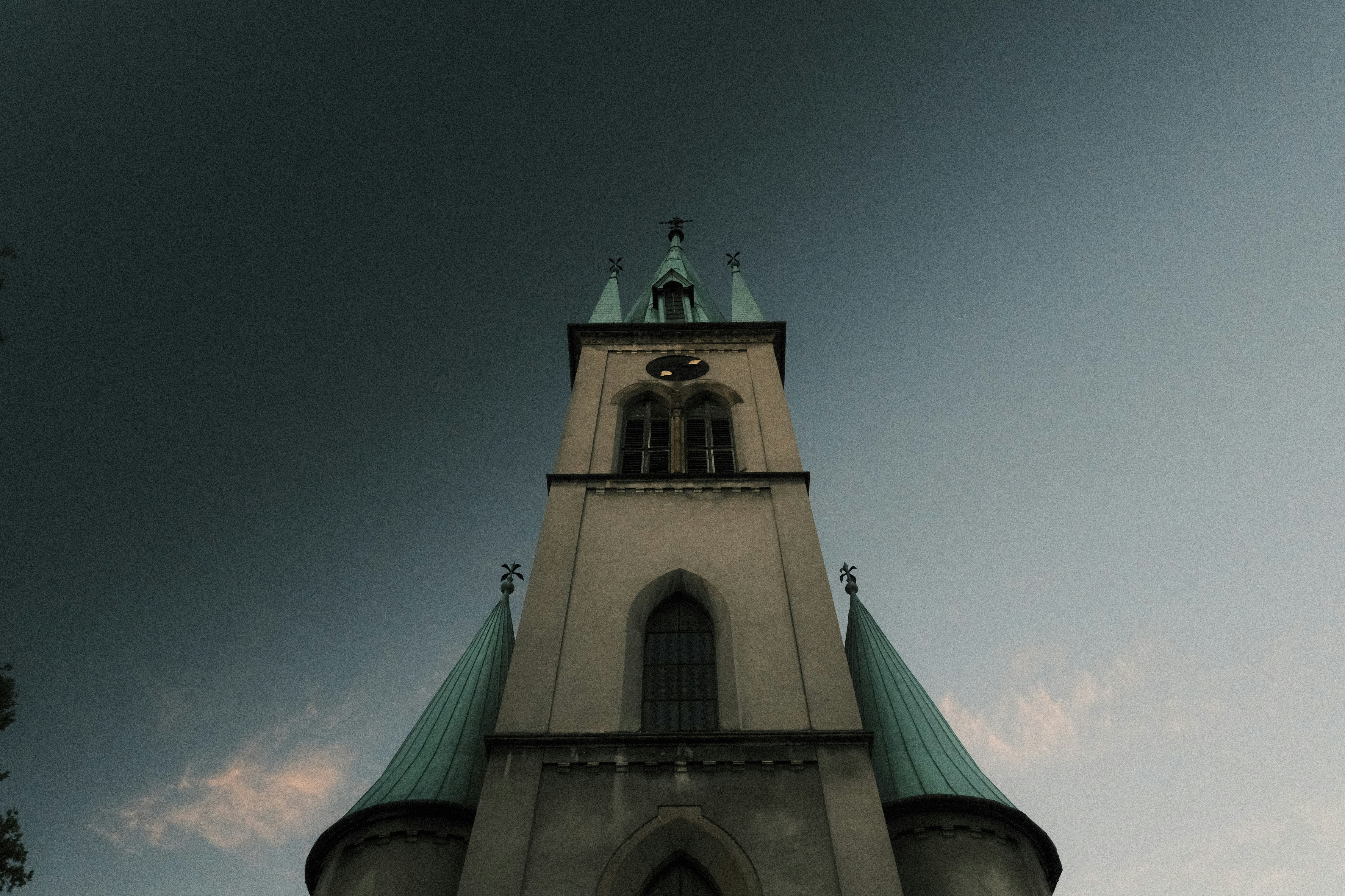Upward Gaze at a Cathedral Spire under a Dawn Sky
