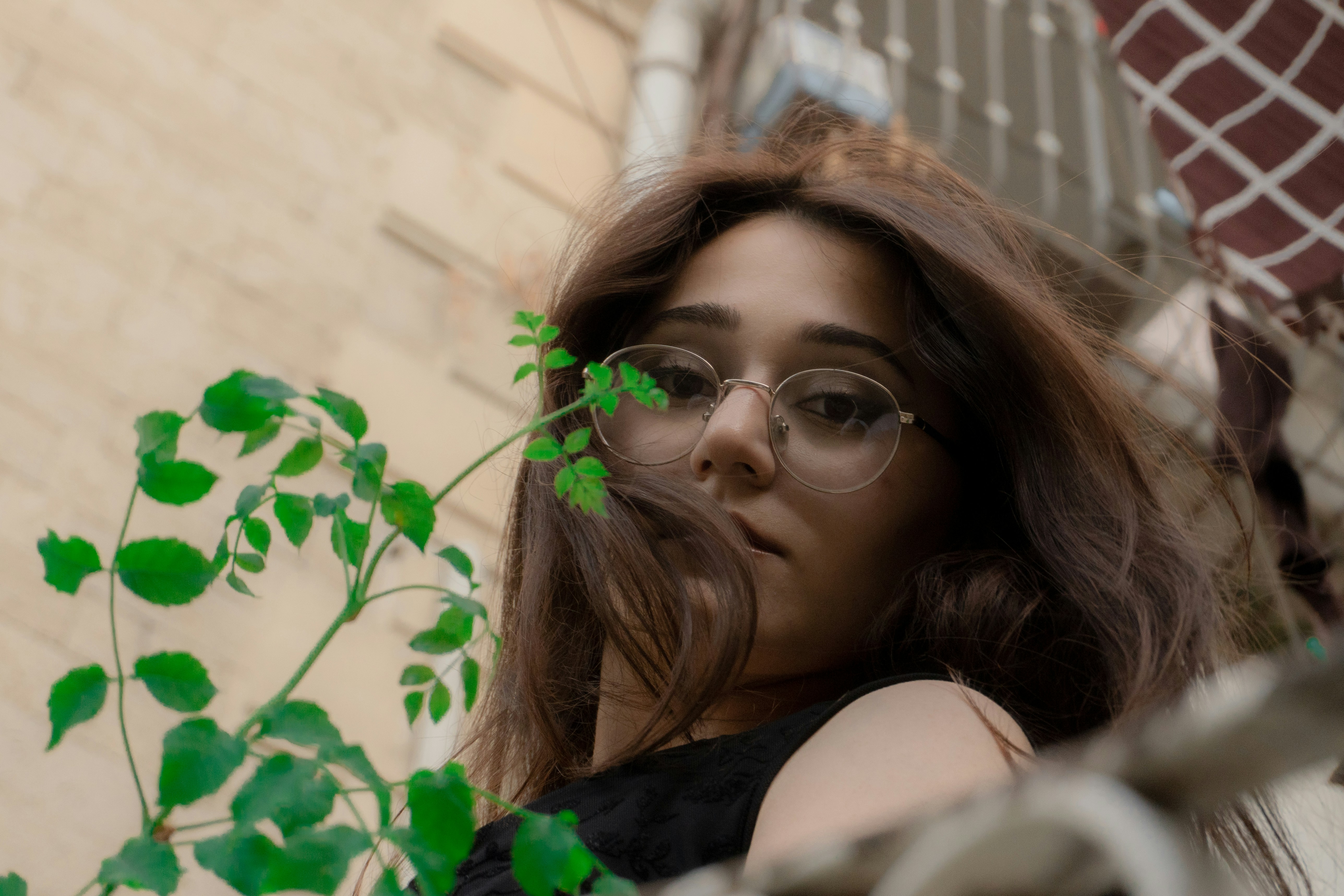 Eyes Beyond the Ivy: Portrait in an Urban Veranda