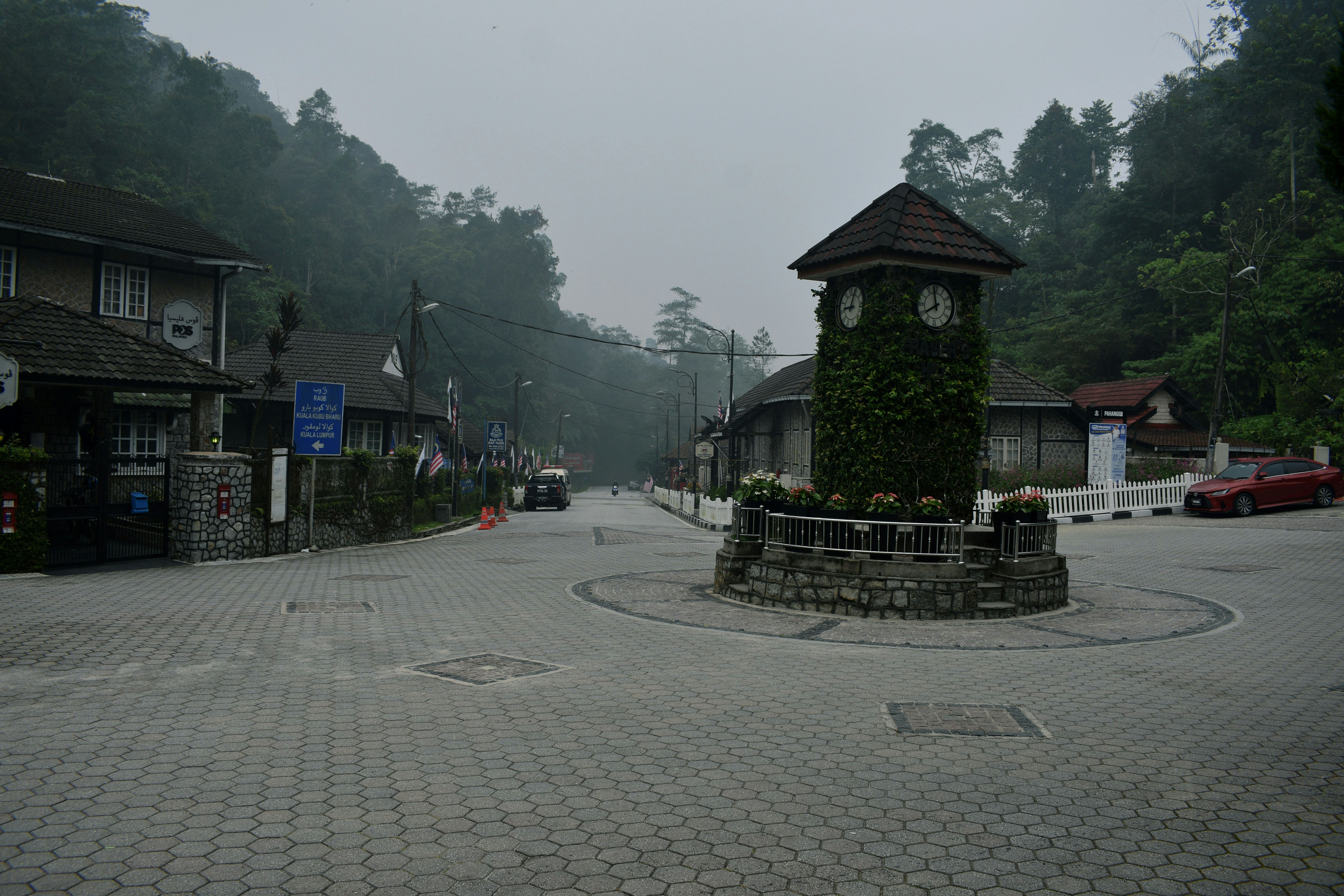 Clocktower Square — Calm Village Roundabout with Ivy-Wrapped Monument