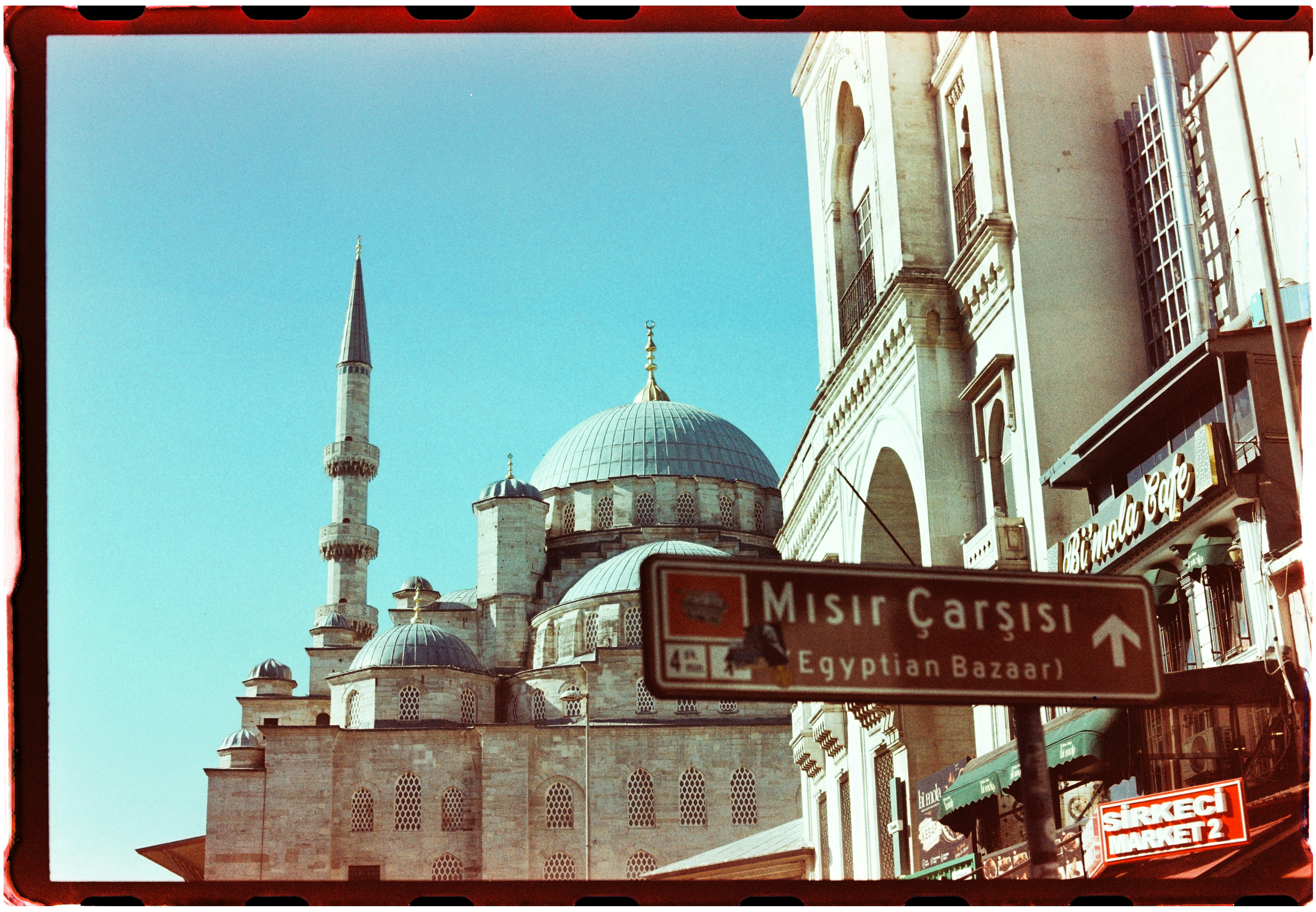 A Turquoise Sky Over Istanbul: The Mosque and Signpost Framing the Street