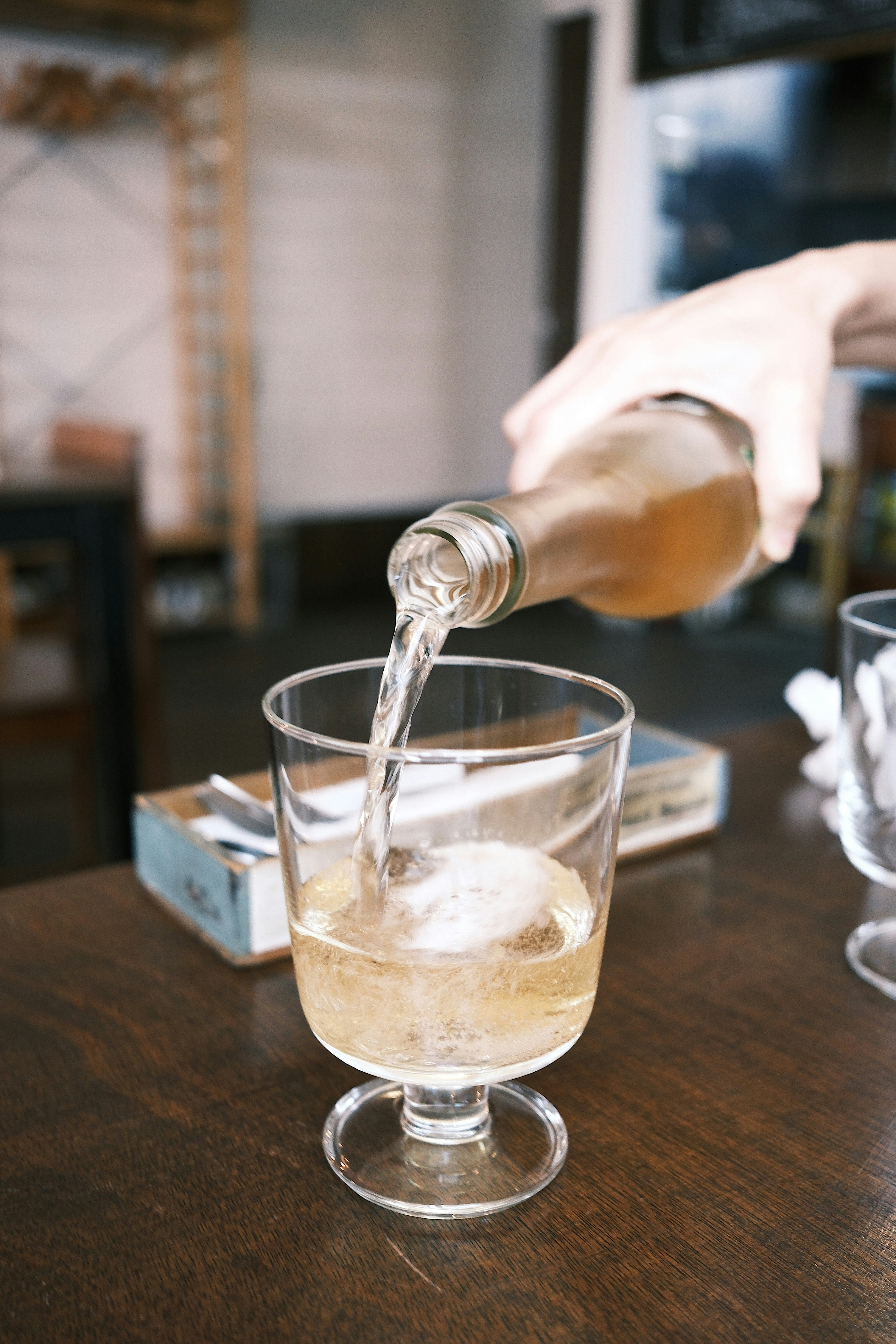 Pouring Clarity: A Glass of Gentle Bubbles in Midpour