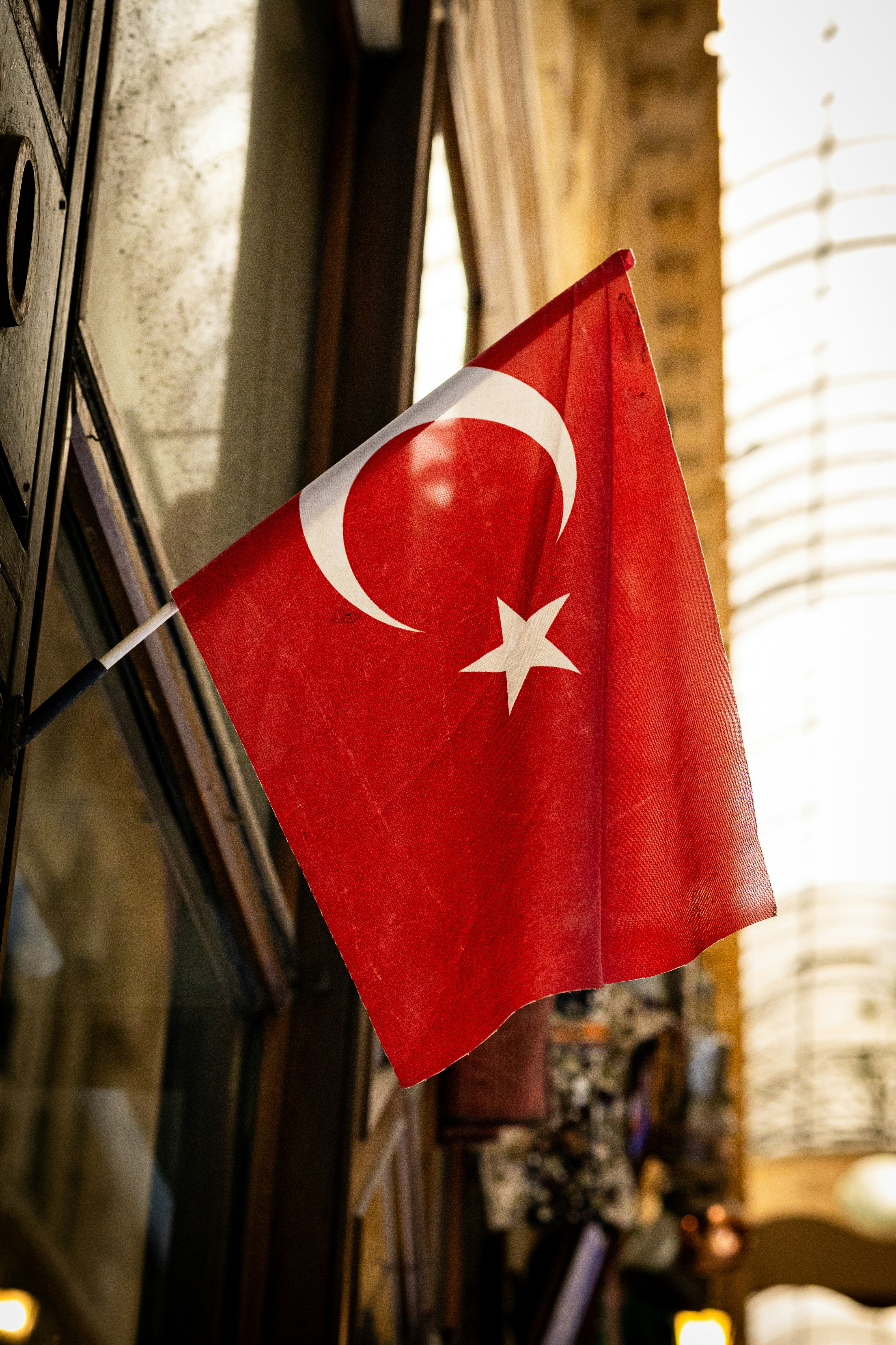 Flag in a Narrow Street: A Red Crescent and Star in Focus