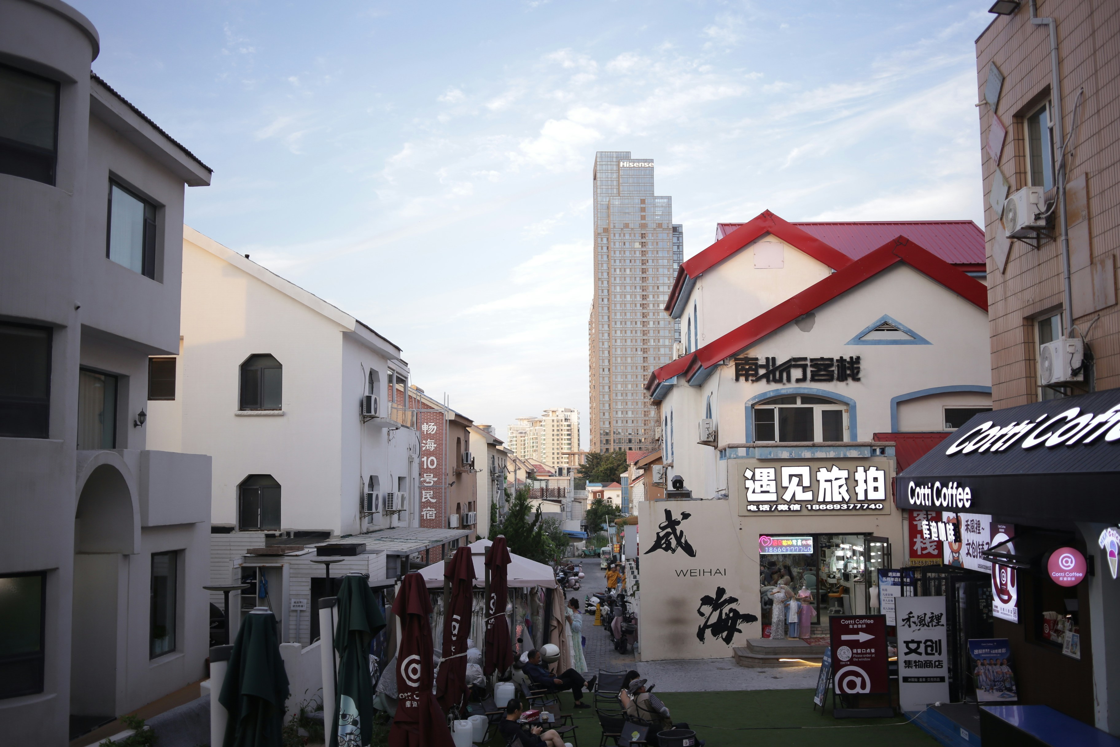 Urban Alleyway Café Pulse: Sunlit Streets Meet Modern Towers